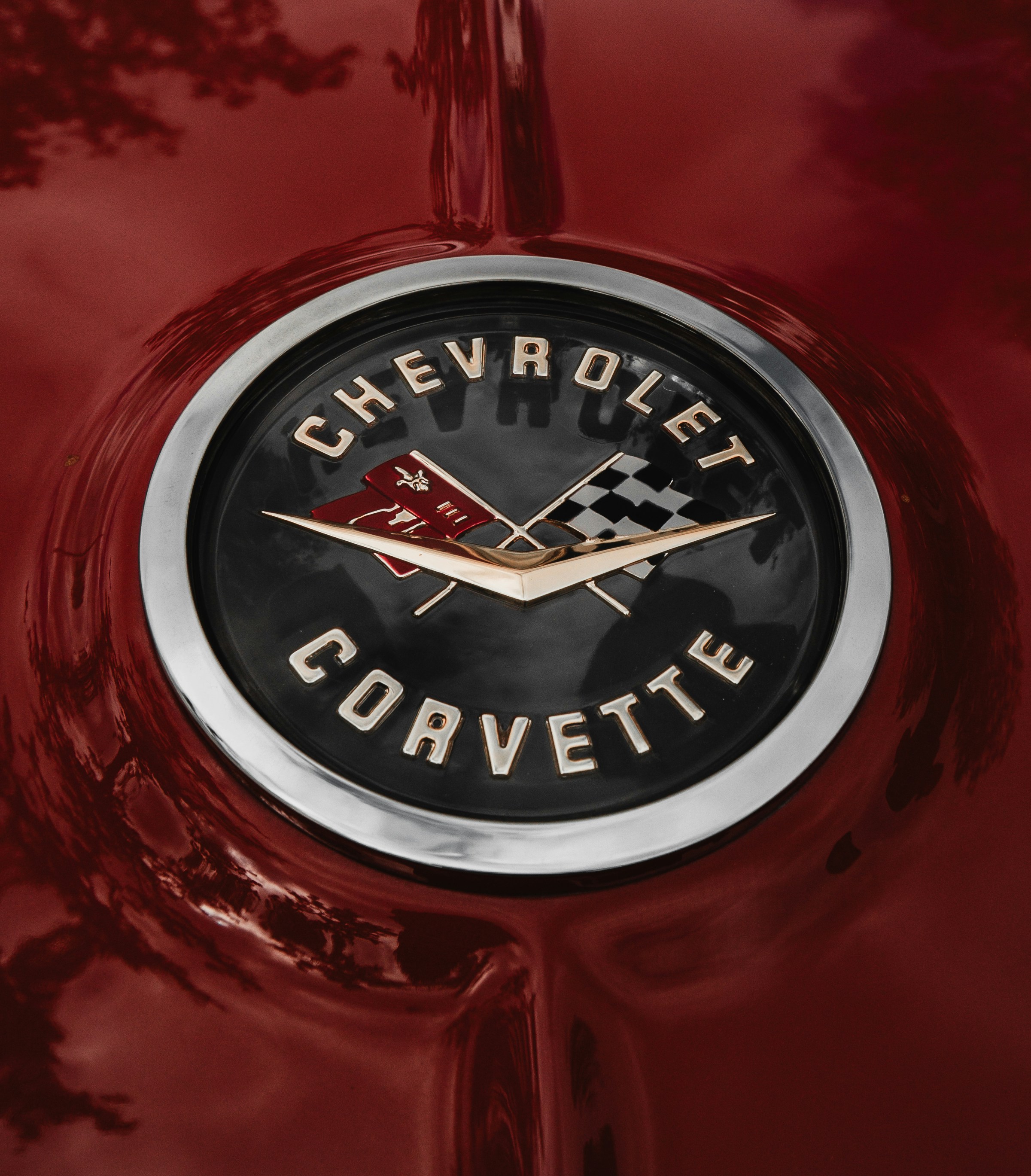 Emblem of Velocity: The Chevrolet Corvette Hood Ornament in Crimson Gloss
