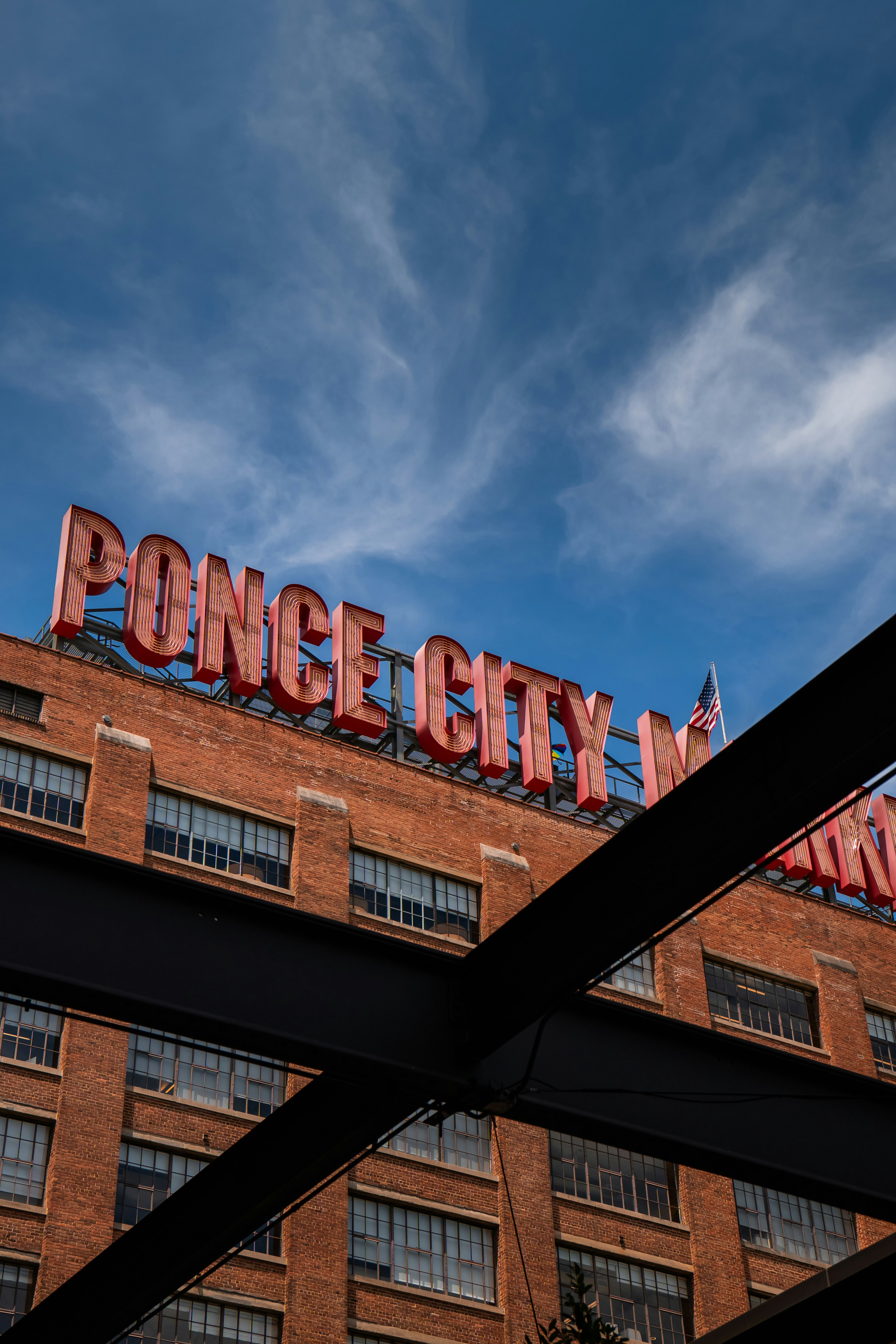 Pinnacle of Ponce: Rooftop Sign Pierced by Steel Crossbars