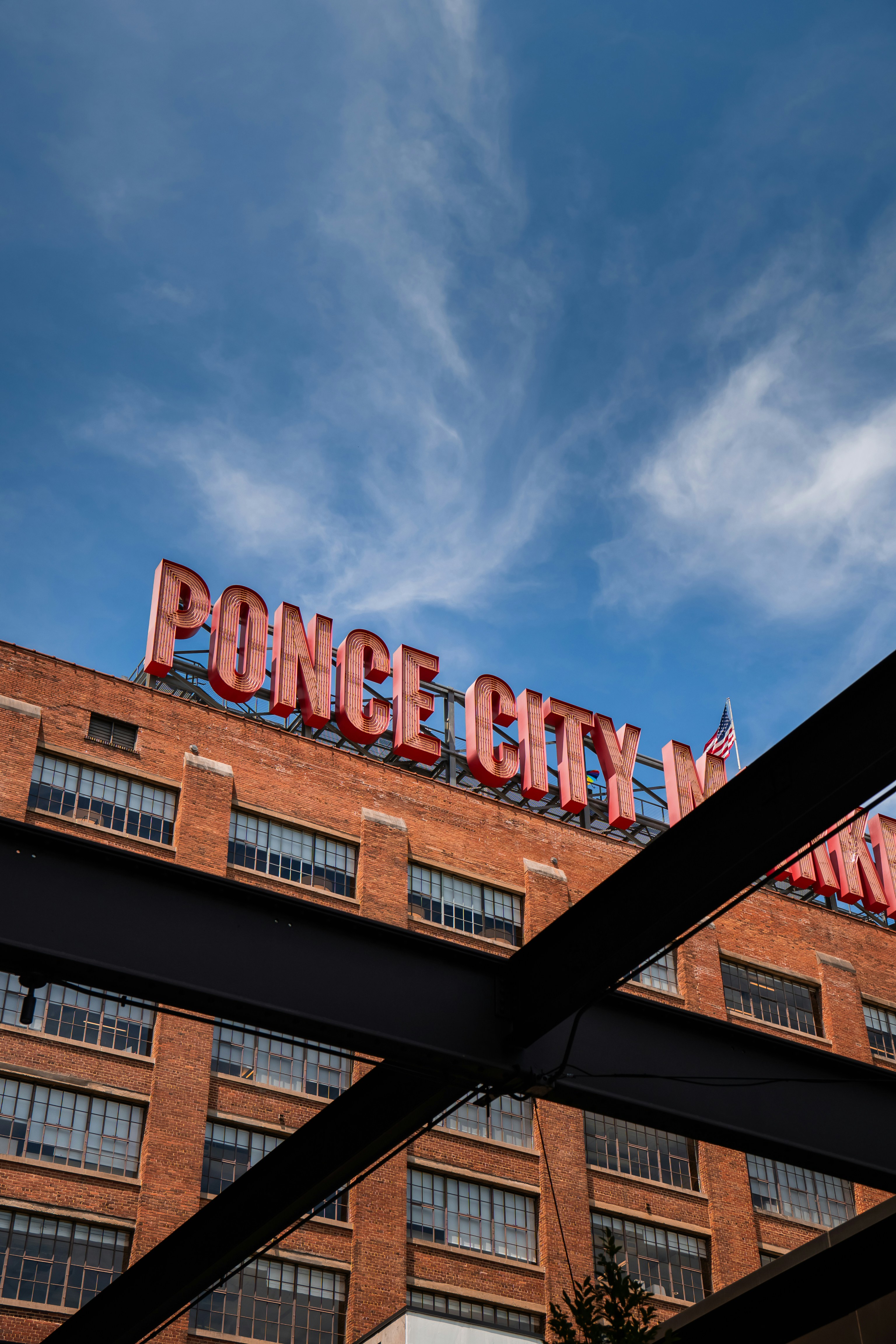 Brick Skyline and Steel Beams Under a Bright Urban Sky