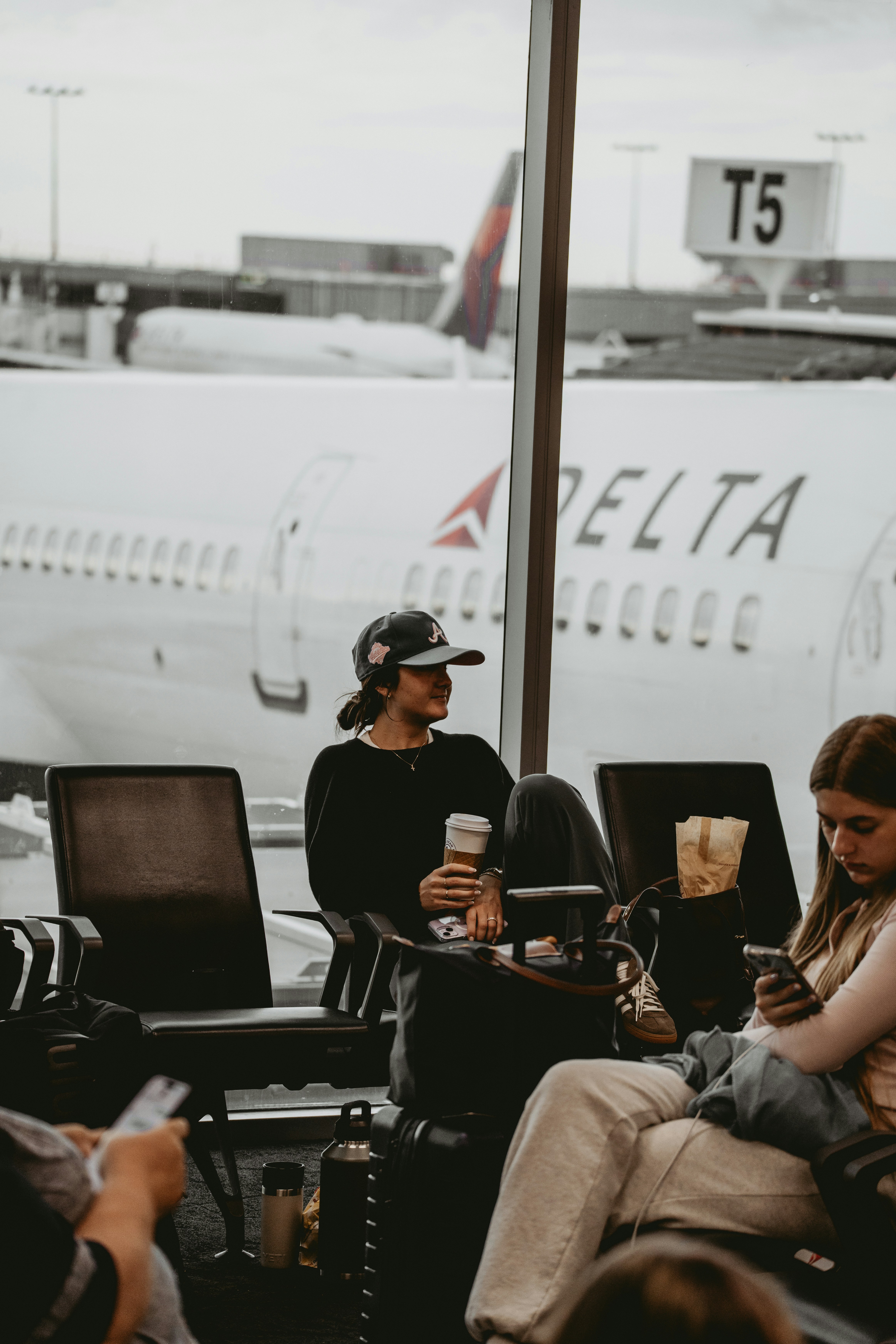 Traveler Pause: Coffee Break Near Gate T5 by a Delta Jet