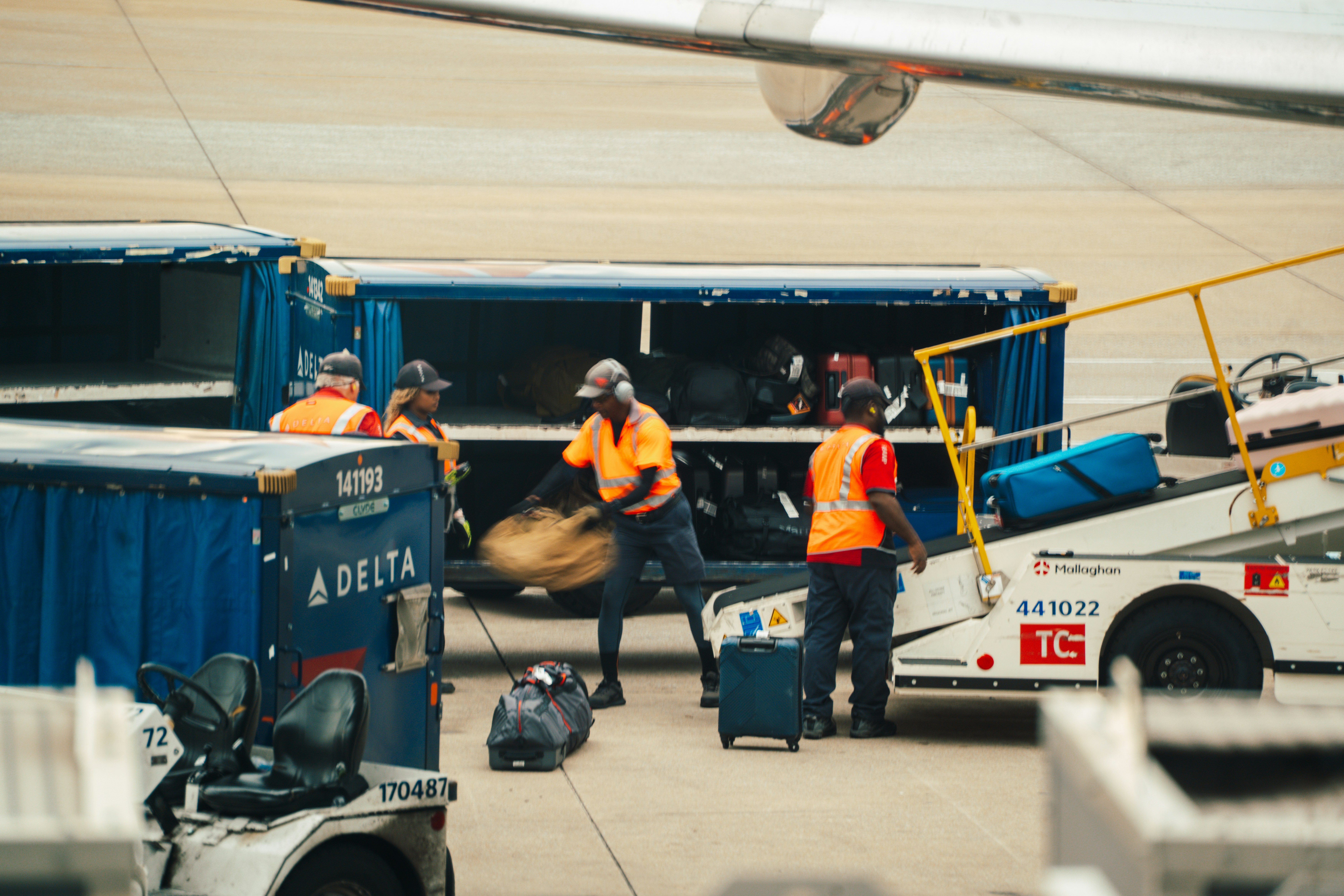 Ground Crew in Action: Baggage Transfer at the Jet Bridge