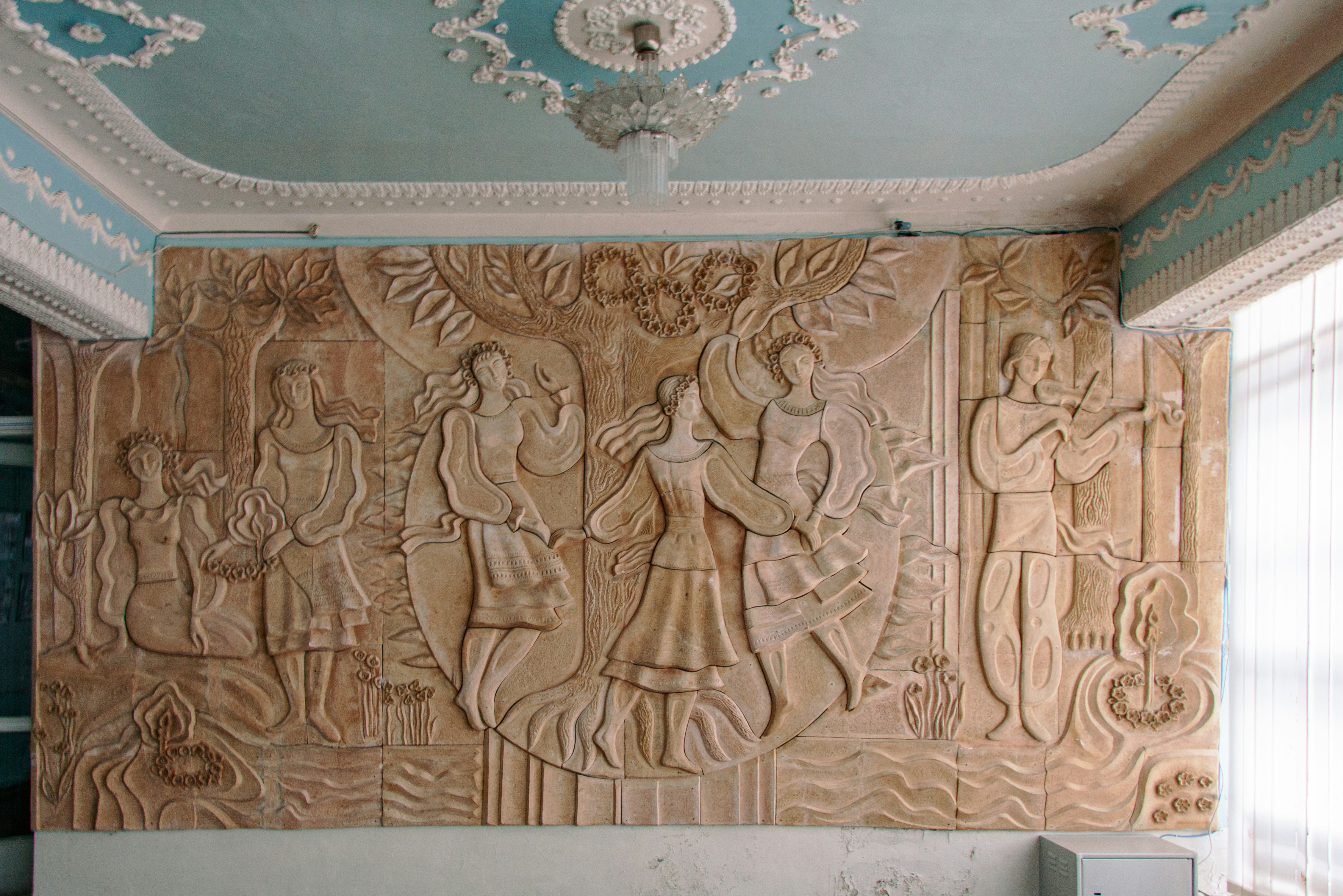 Carved Frieze of Dancers Beneath Ornate Ceiling