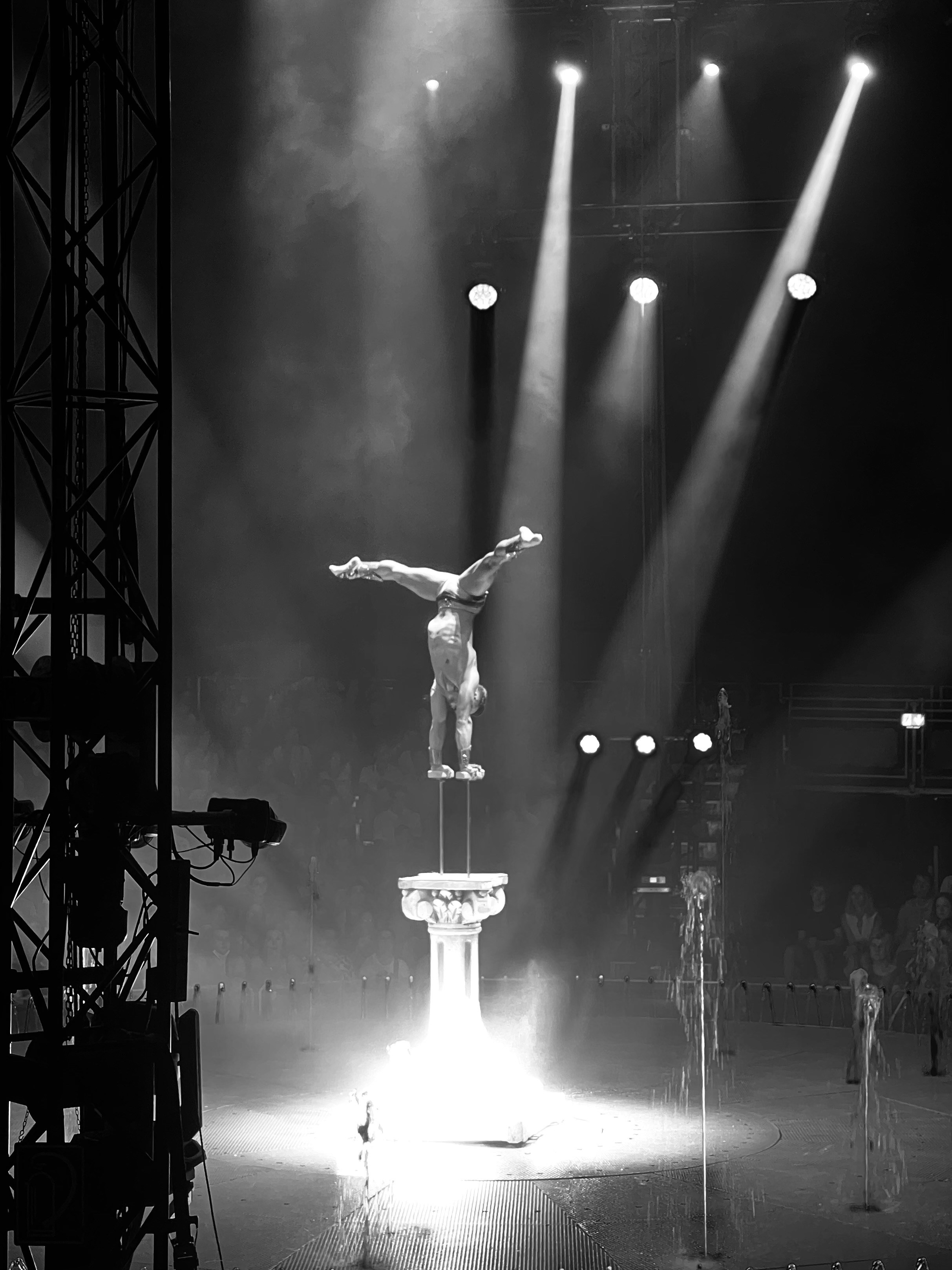 A Solemn Aerial: The Strongman on a Glowing Pedestal