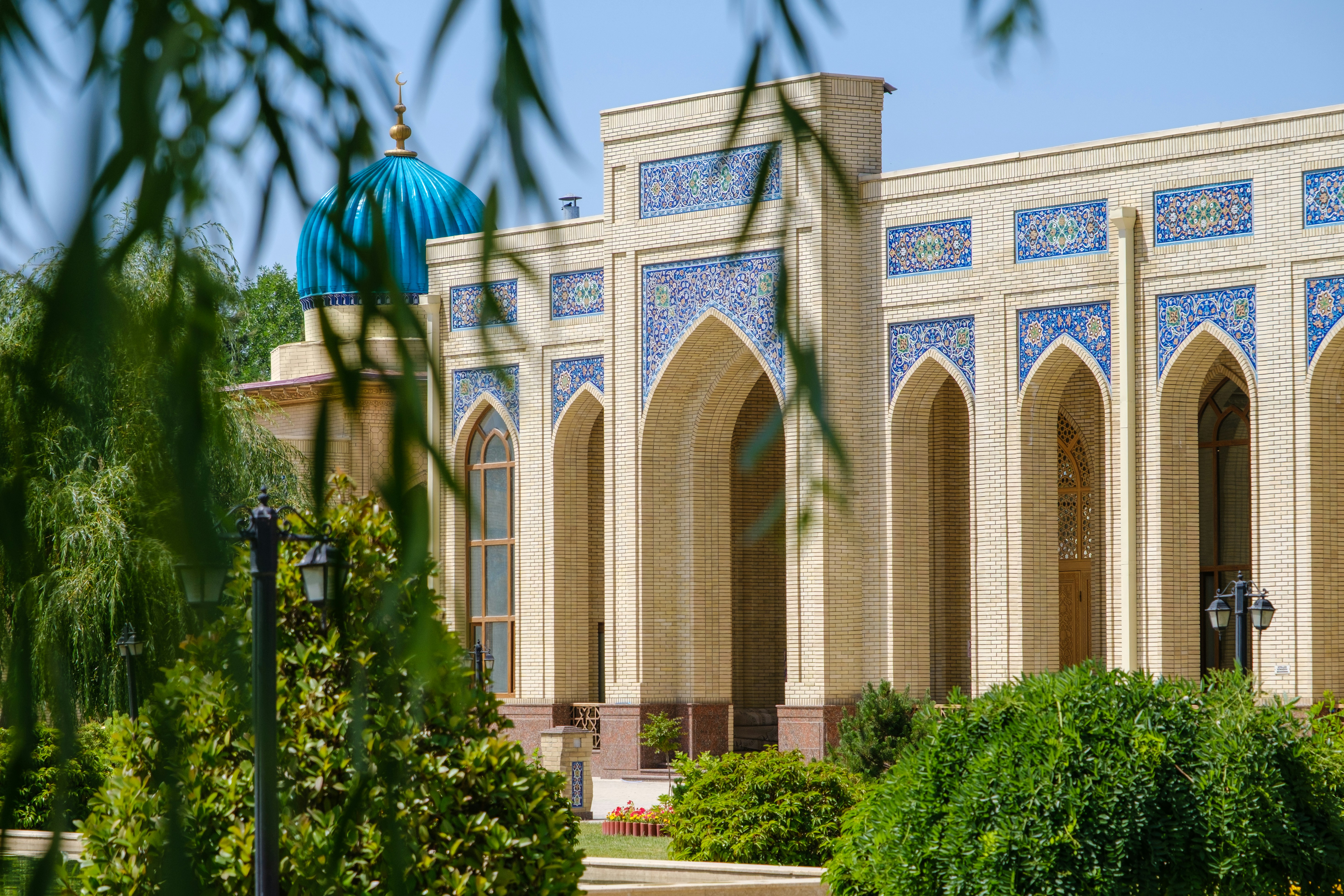 Blue-domed gateway framed by lush greenery