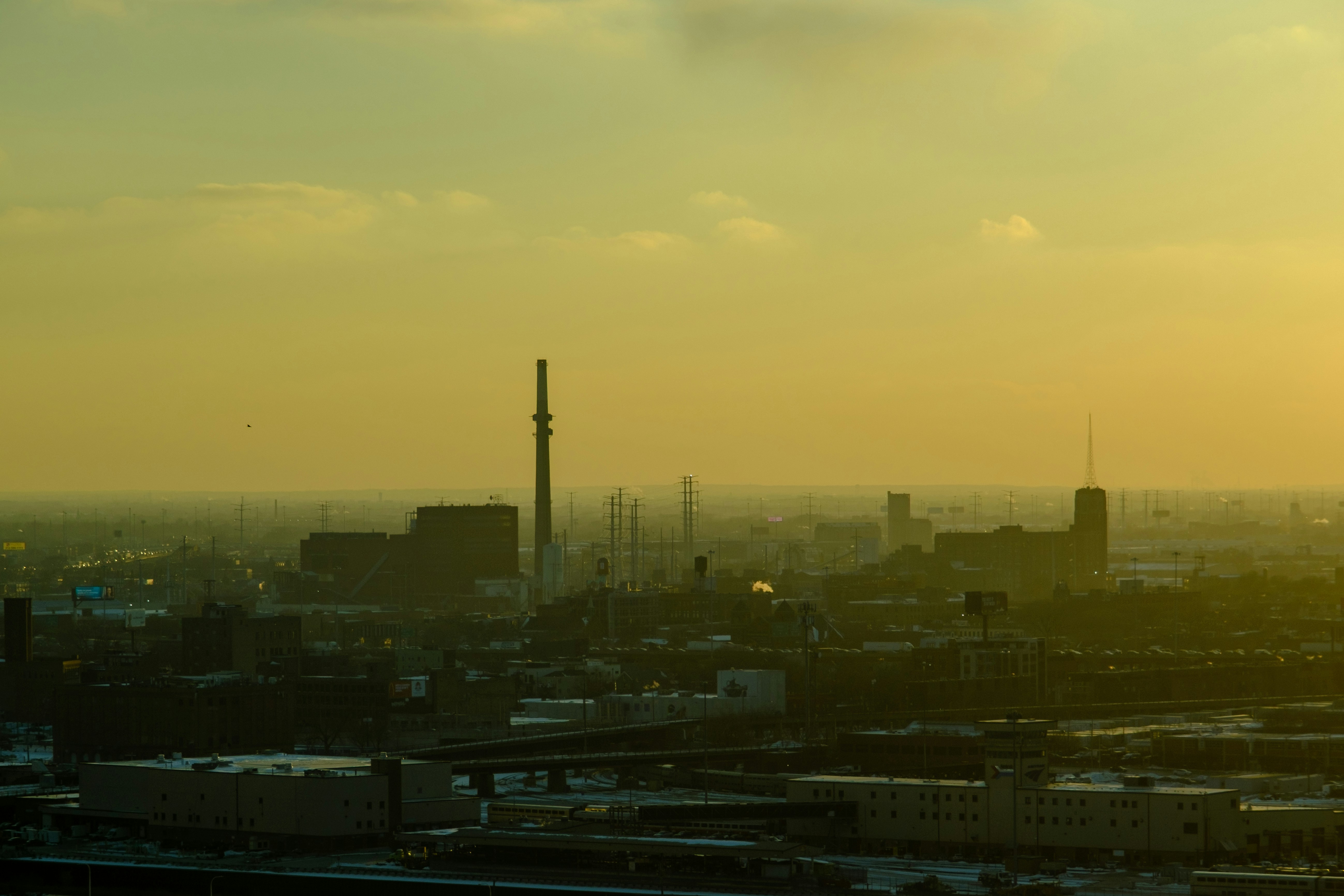 Industrial Horizon at Dusk: A Quiet City Against a Golden Sky