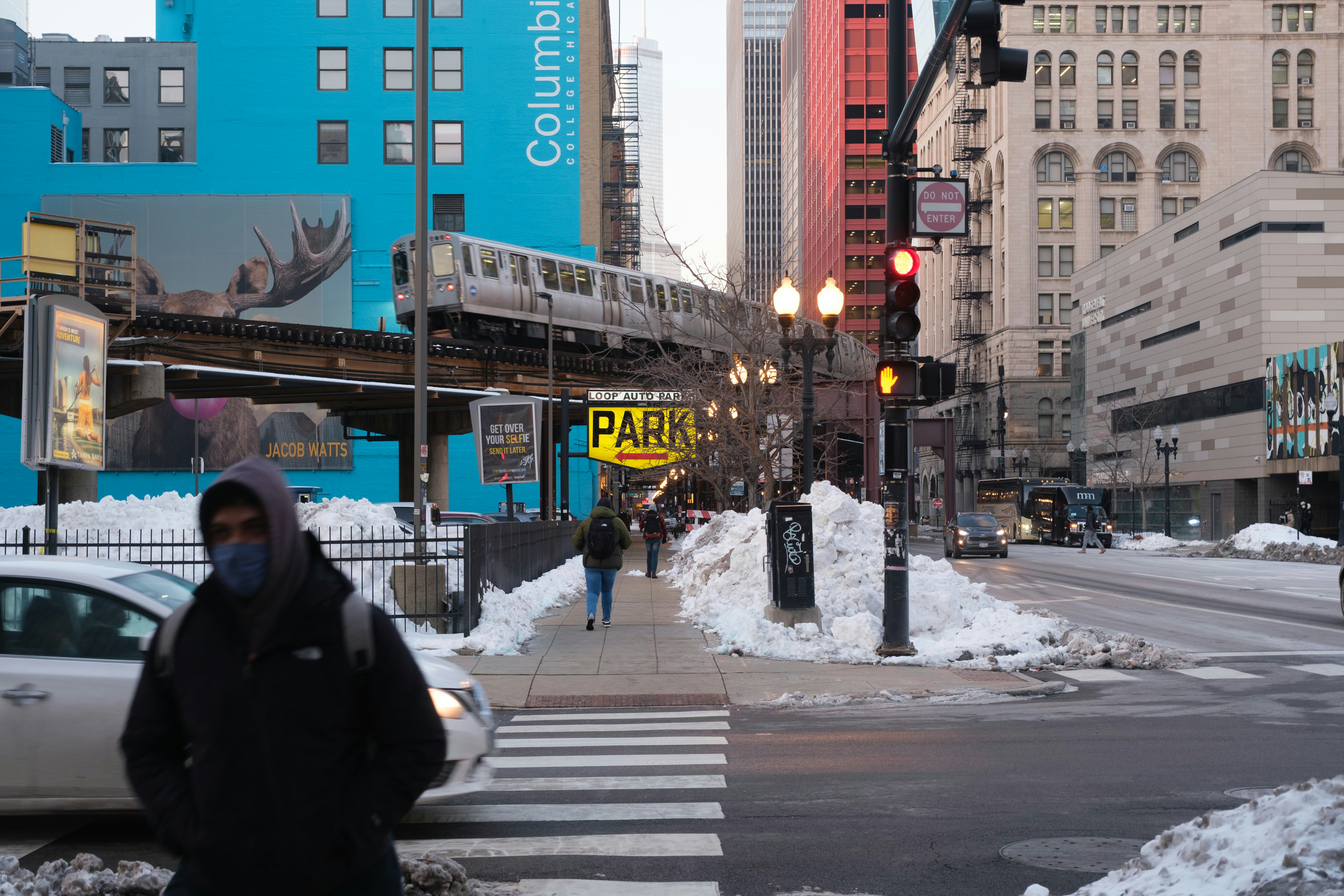 Snowy City Crossing Under Elevated Transit