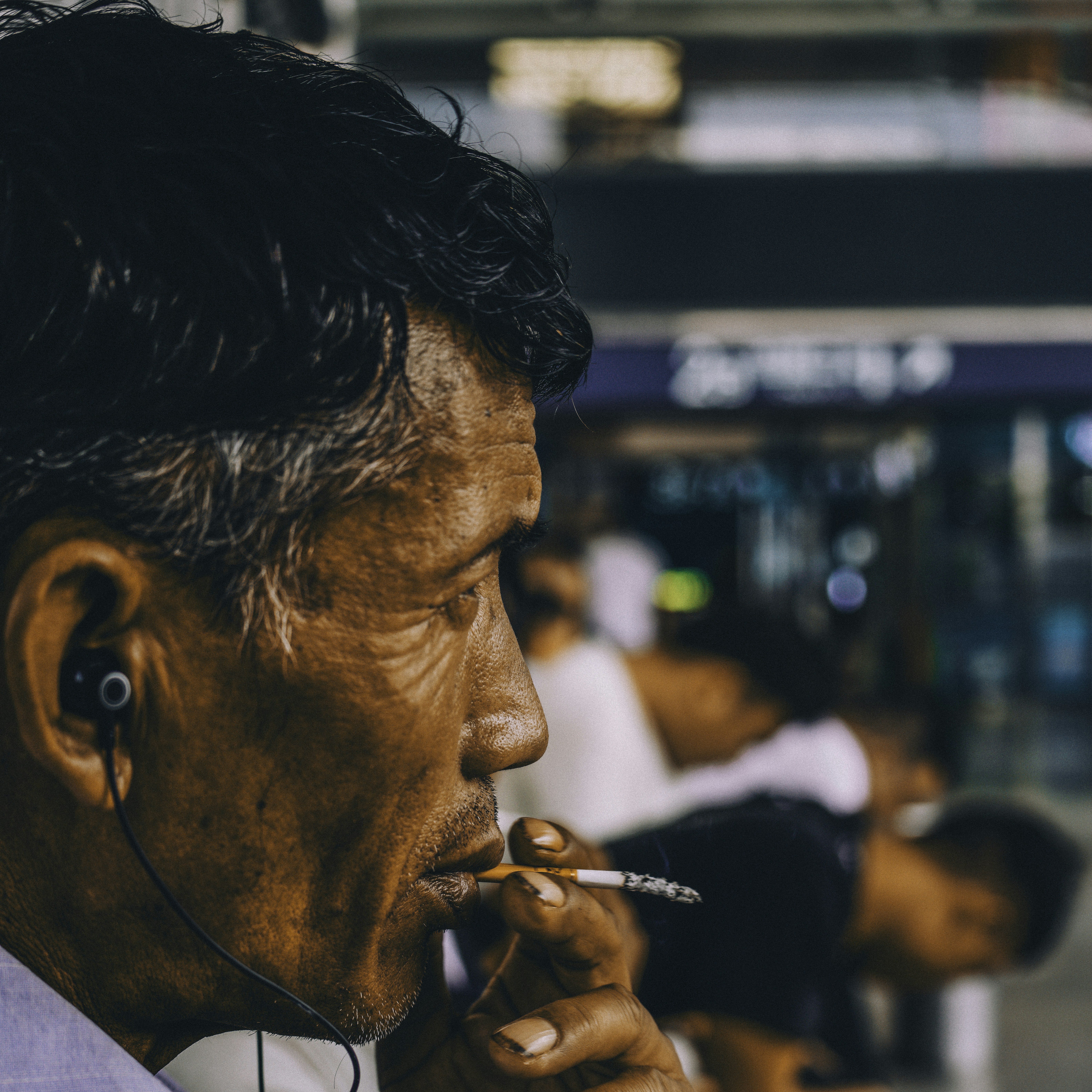 Smoker in a Quiet Moment: Portrait in a Busy Space