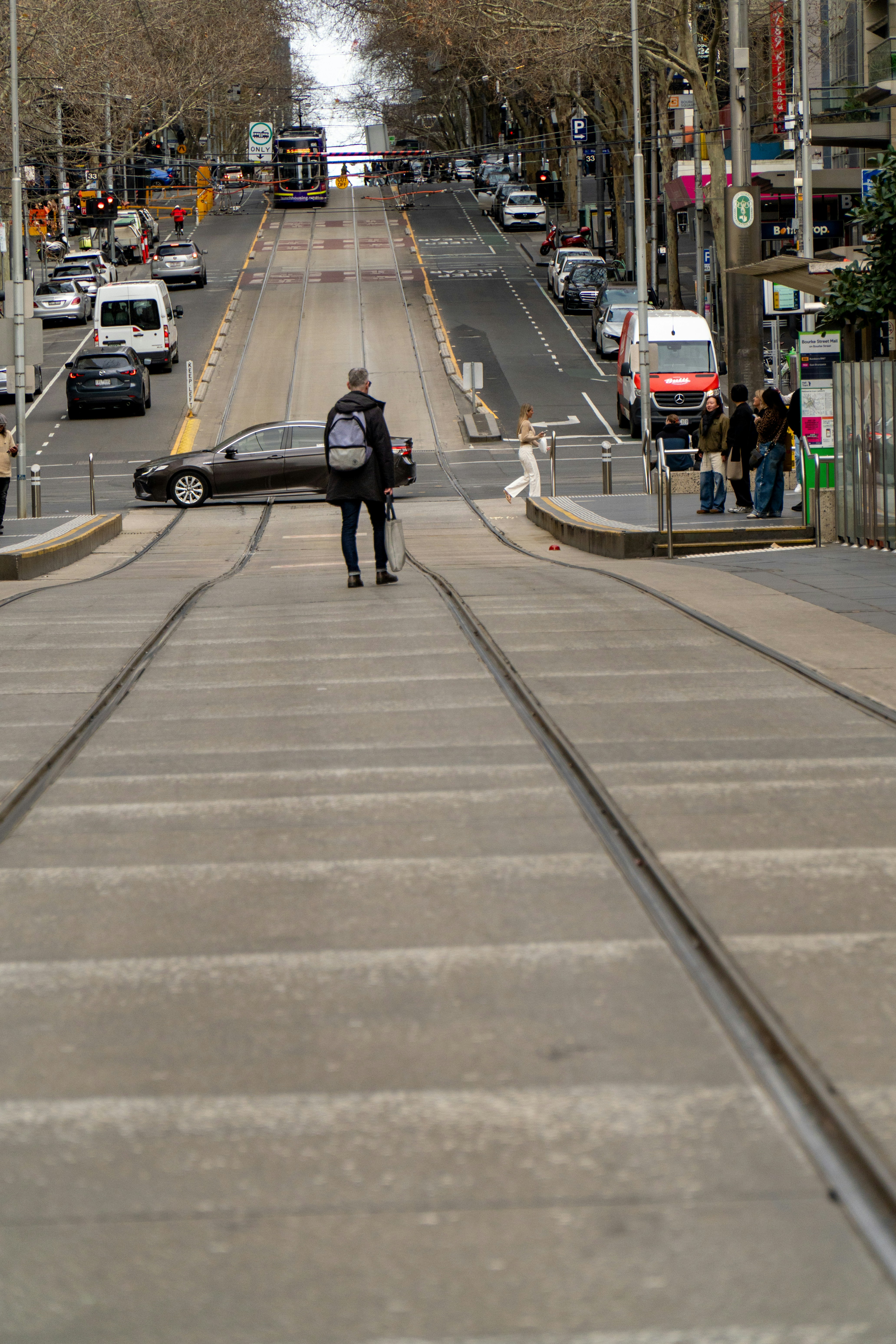 Crossing the Rails: A City Street Barrelling Toward the Hill