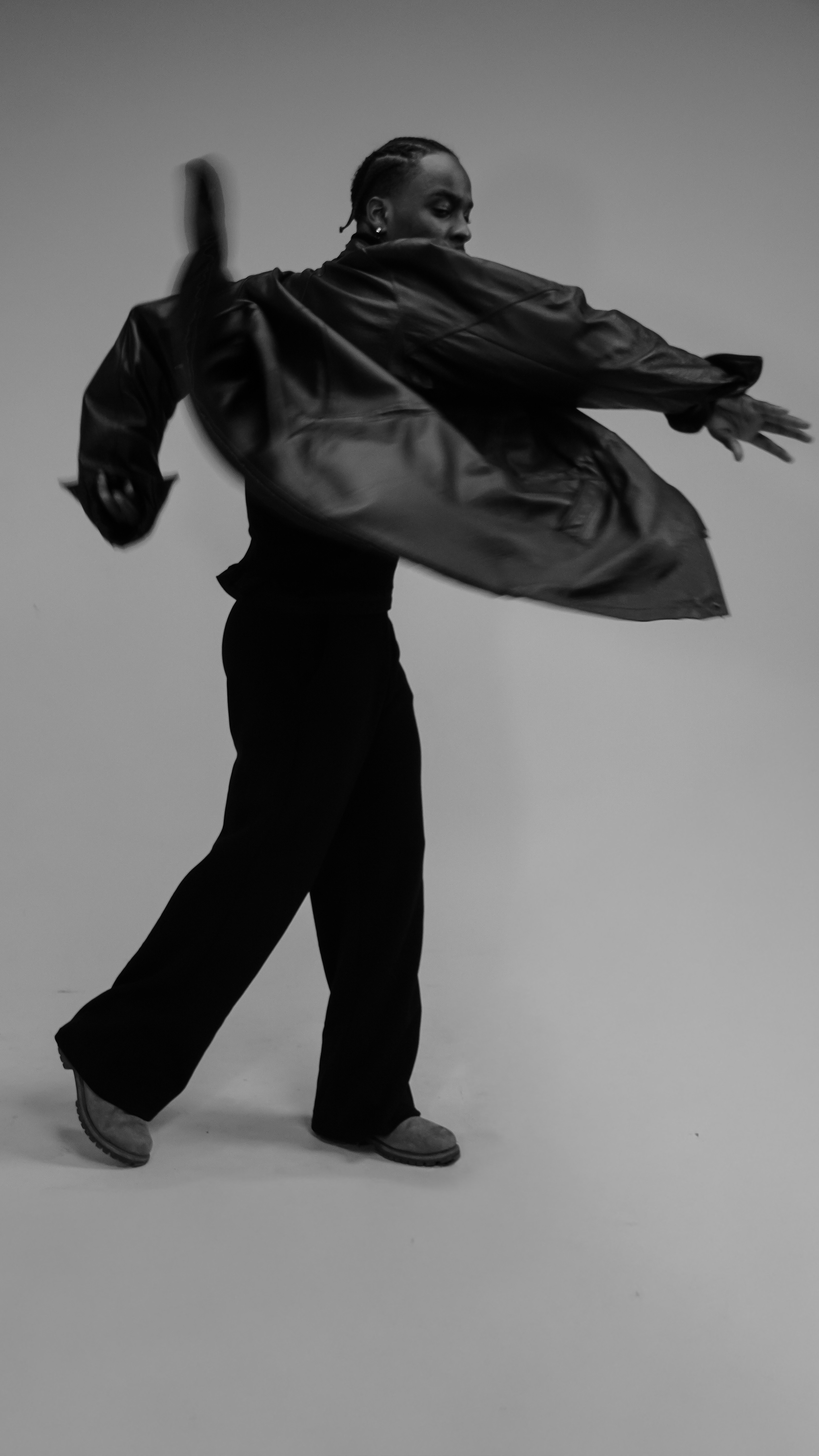 Motion in Shadow: A Dancer Halts Time with a Billowing Coat