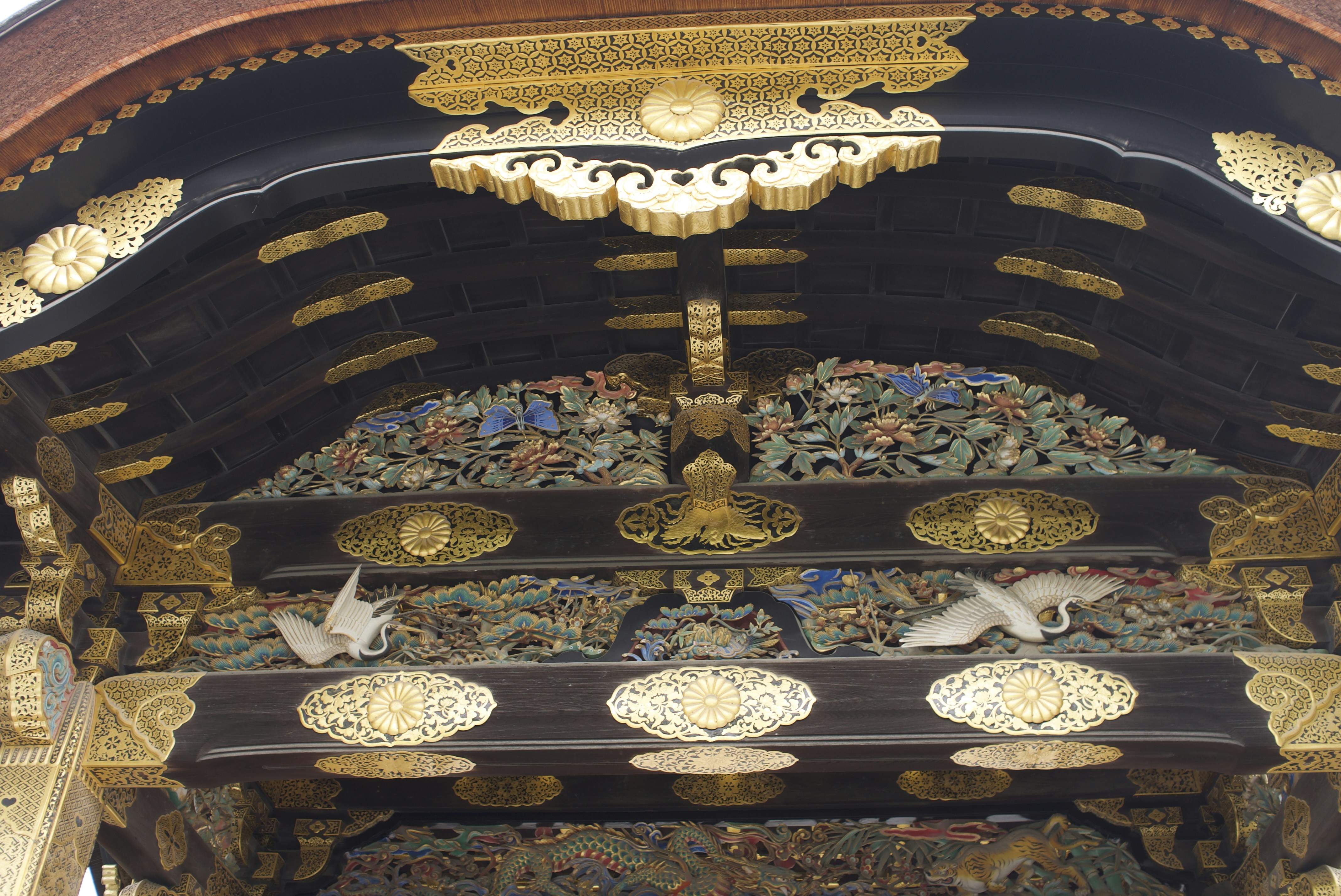 Gilded Carved Eaves: Ornate Dragons and Floral Panels atop a Japanese temple