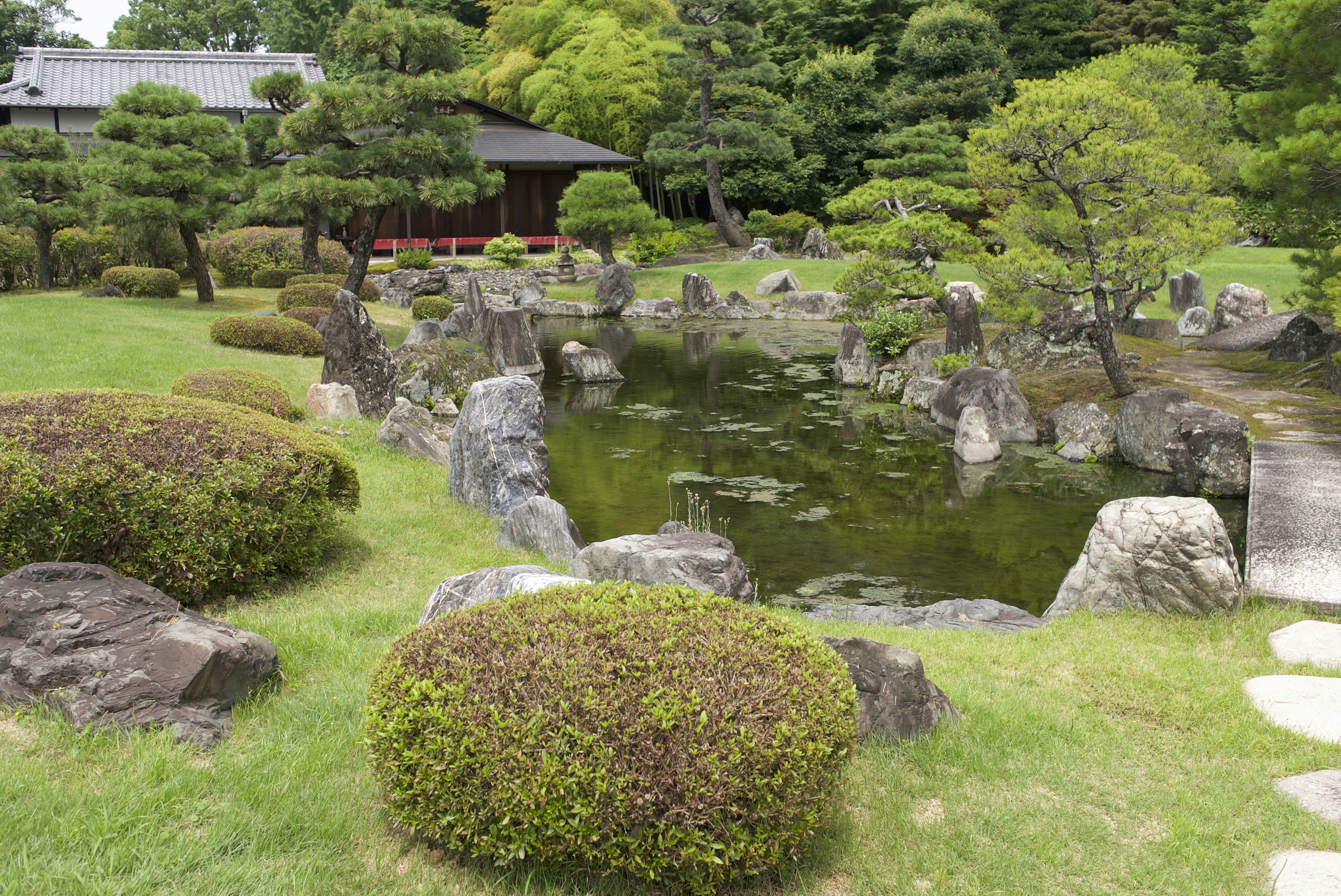 Serene Japanese Garden with Stone Lanterns and Raked Pond