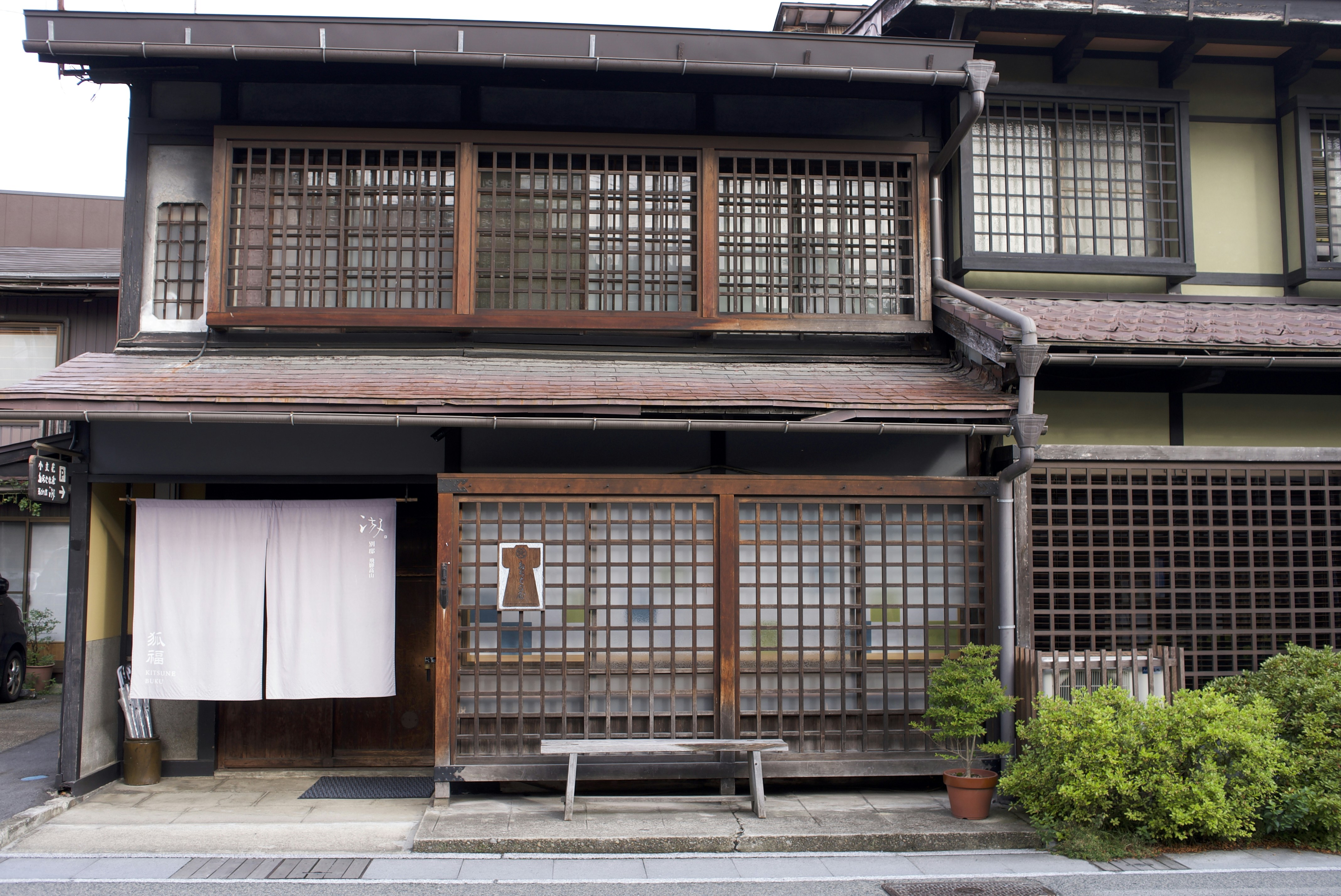 Traditional Facade with Wooden Lattice and Aged Curtain