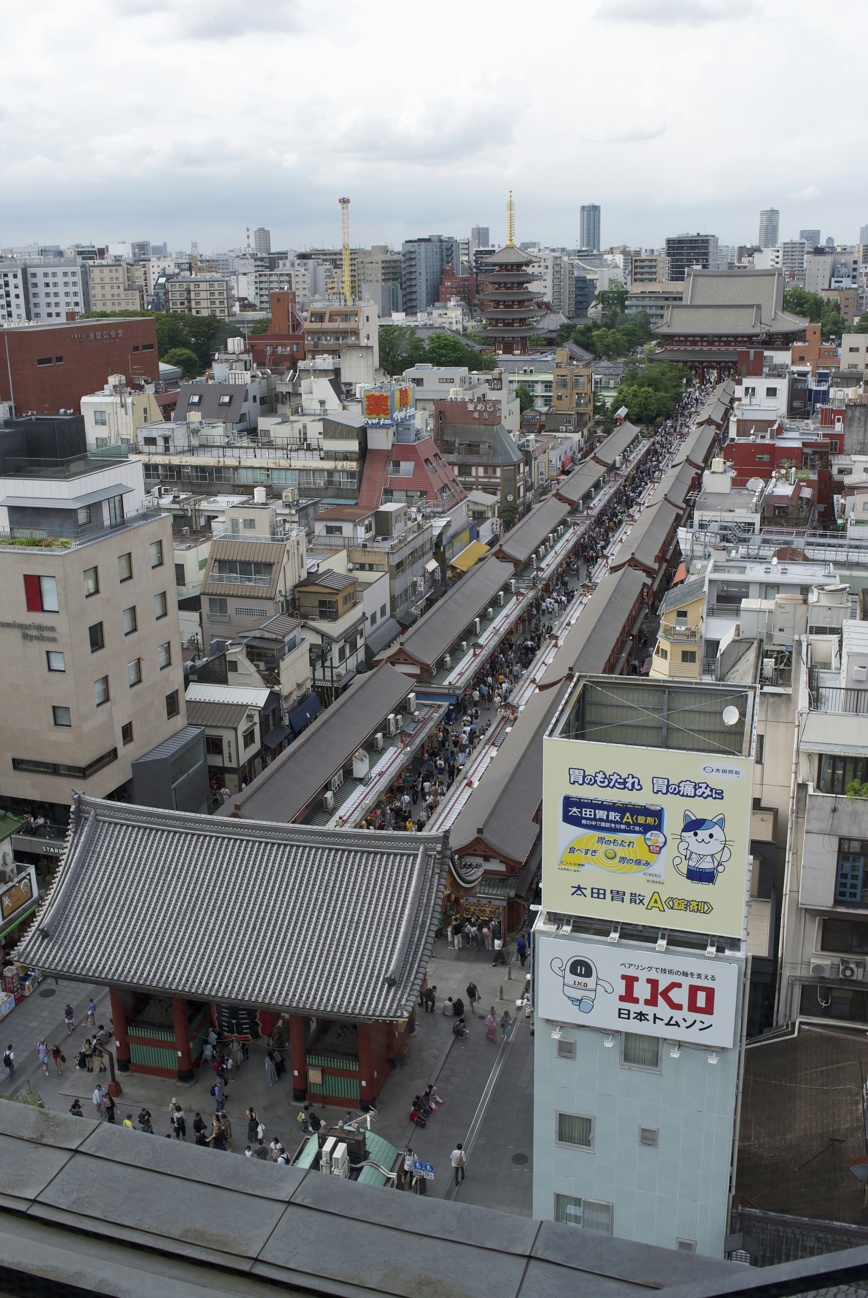 Temple Gate Through a Sea of Shoppers: A Tokyo Market Scene from Above