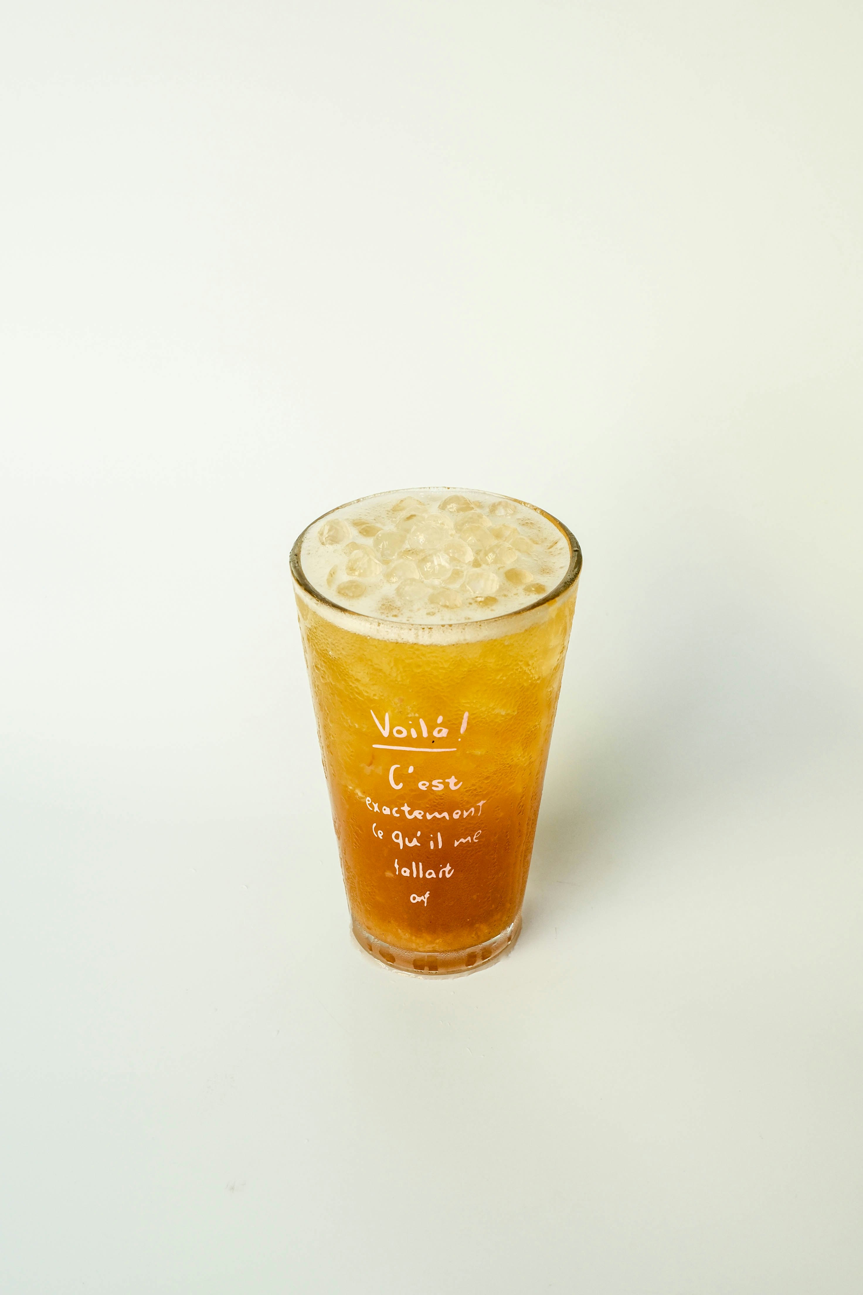 Sunlit Amber: A Glass of Frosted Frosting on White