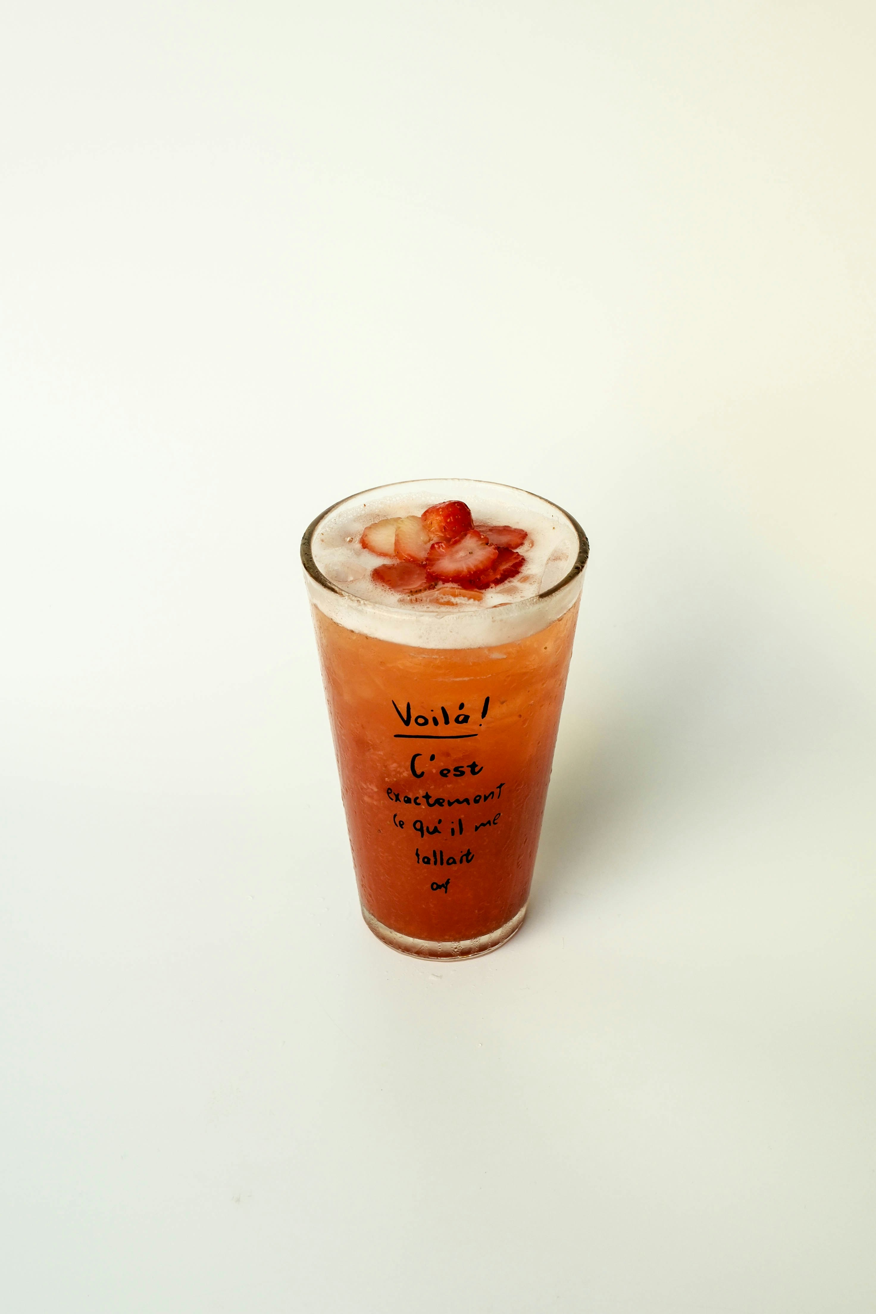 Strawberry Sunrise: A Solo Glass on a Pale Stage
