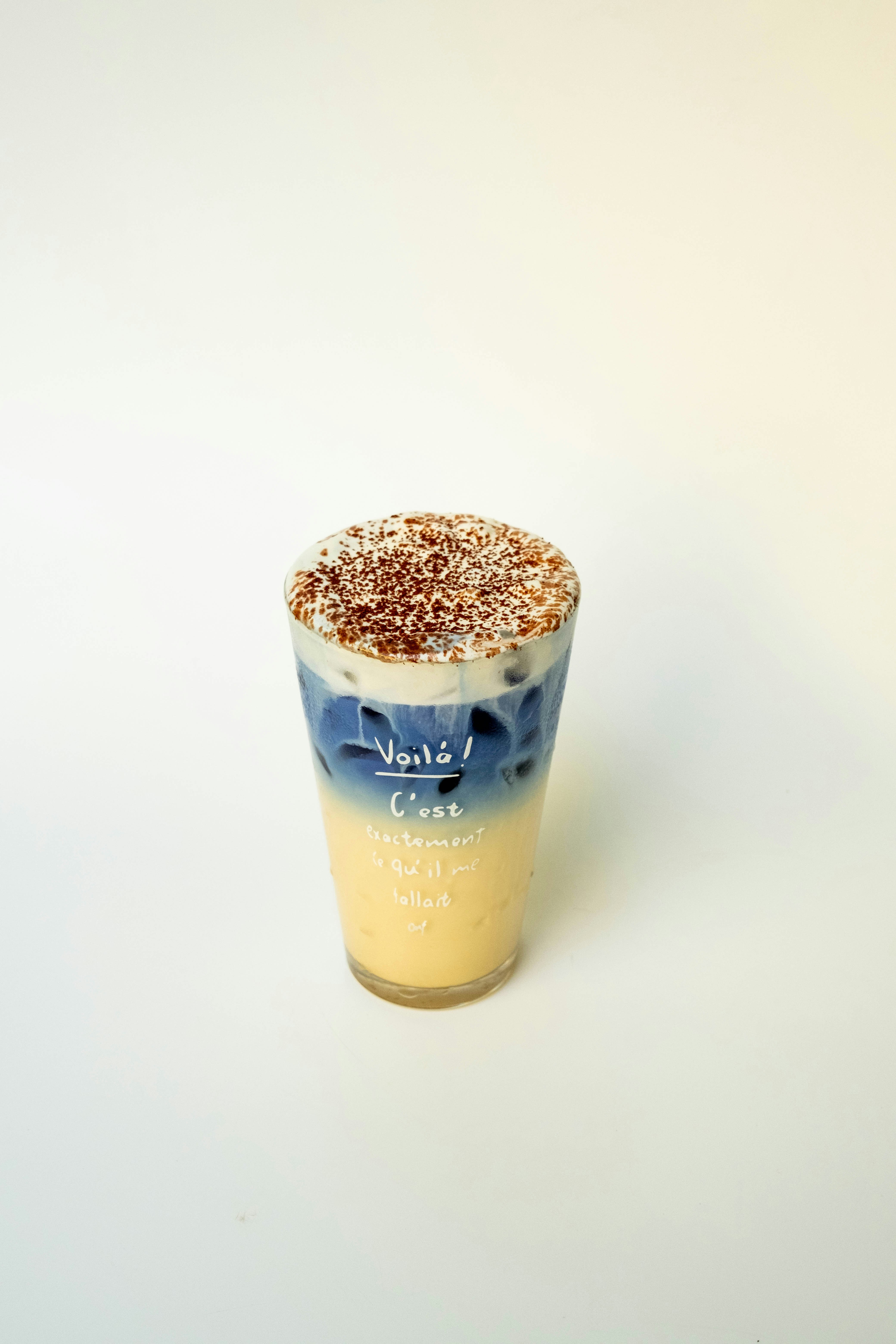 Layered Ambrosia: A Distantly Painted Vanilla-Blue Latte in Focus