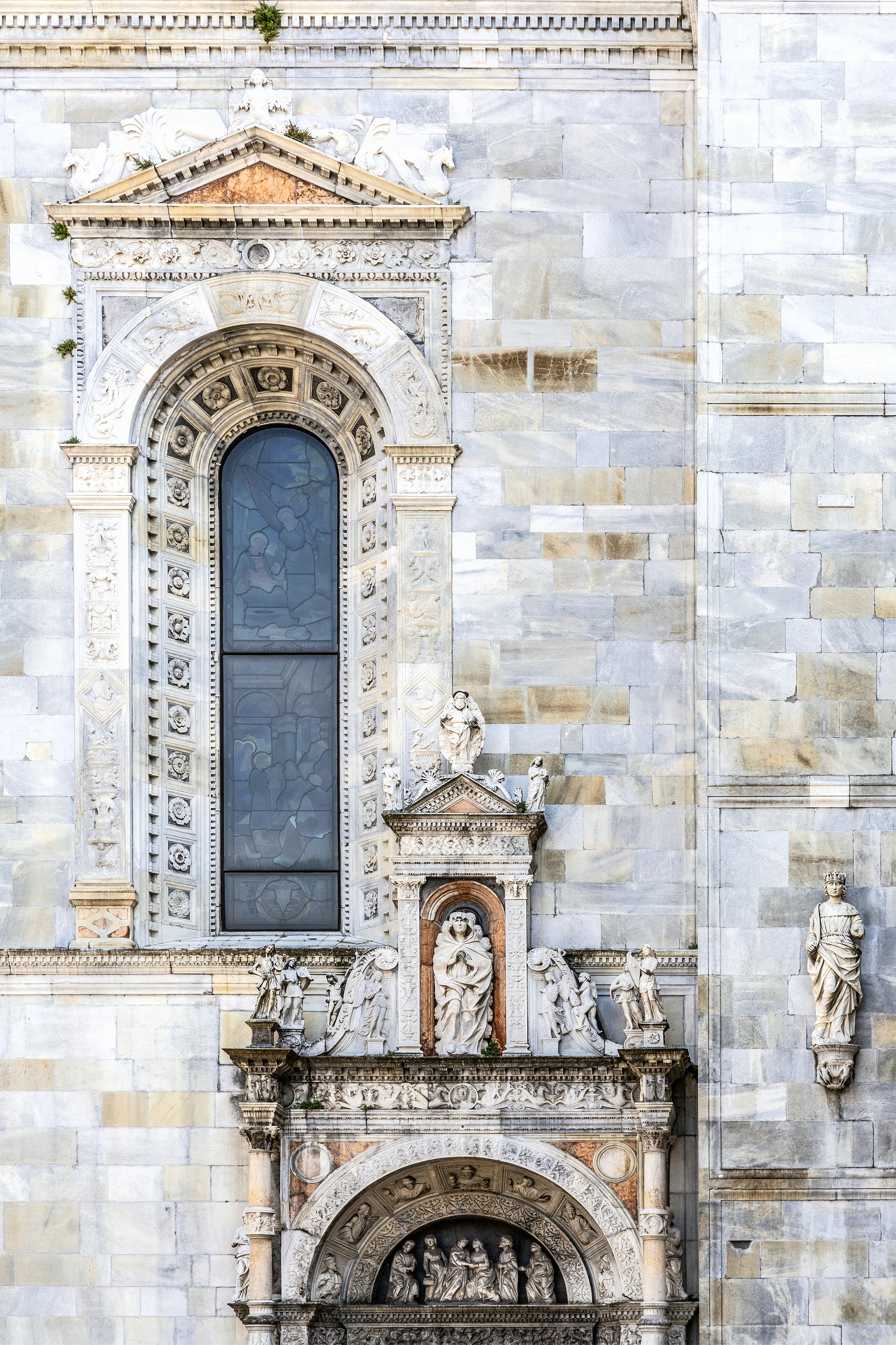 Ornate Portal on Marble Facade: A Study in Sculpted Detail