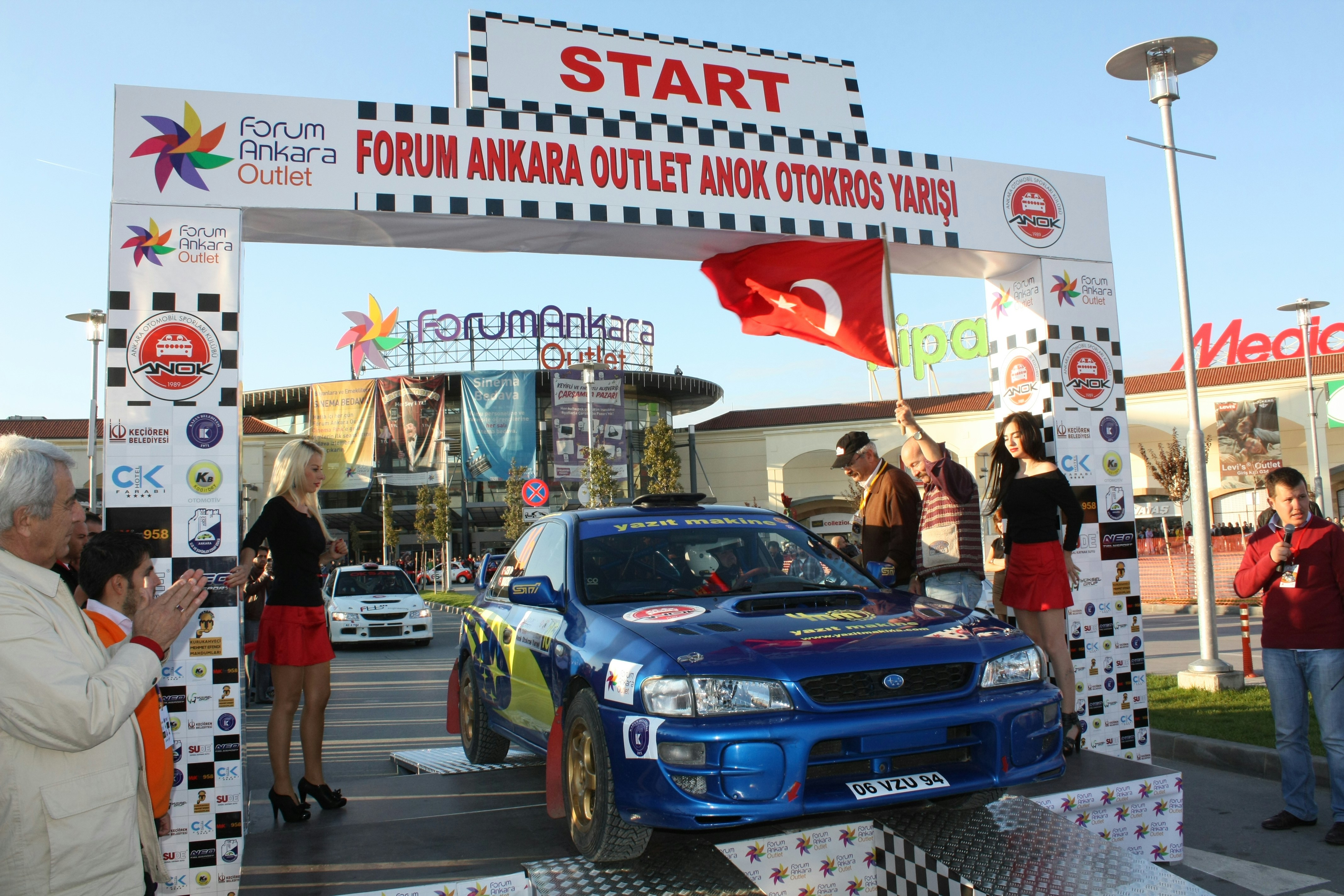 Blue rally car anchors the start gate at Forum Ankara Outlet racing event