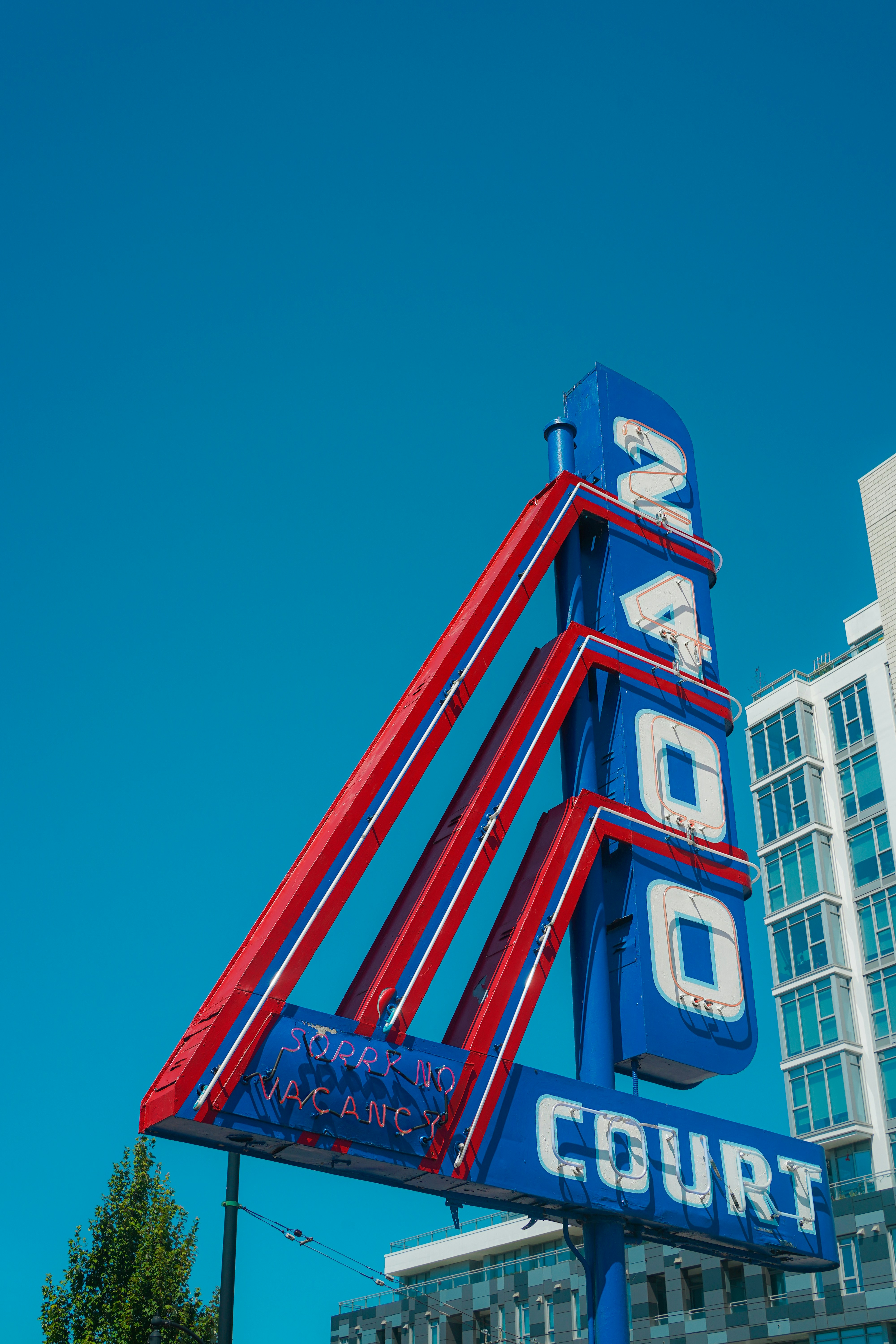 Neon Court Sign Reaches for the Blue Sky