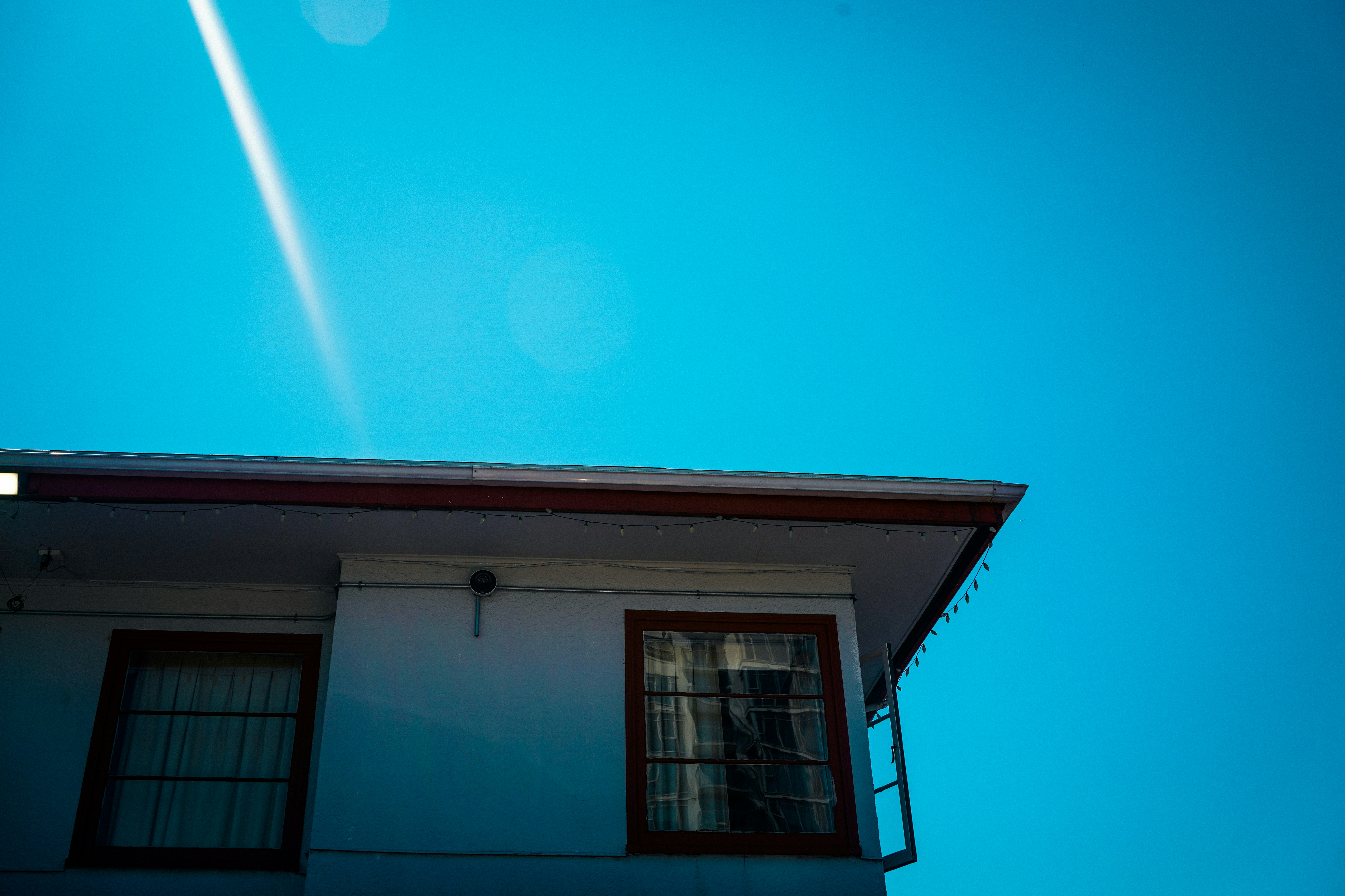 Edge of a Quiet Blue Sky over a Cornered Roof