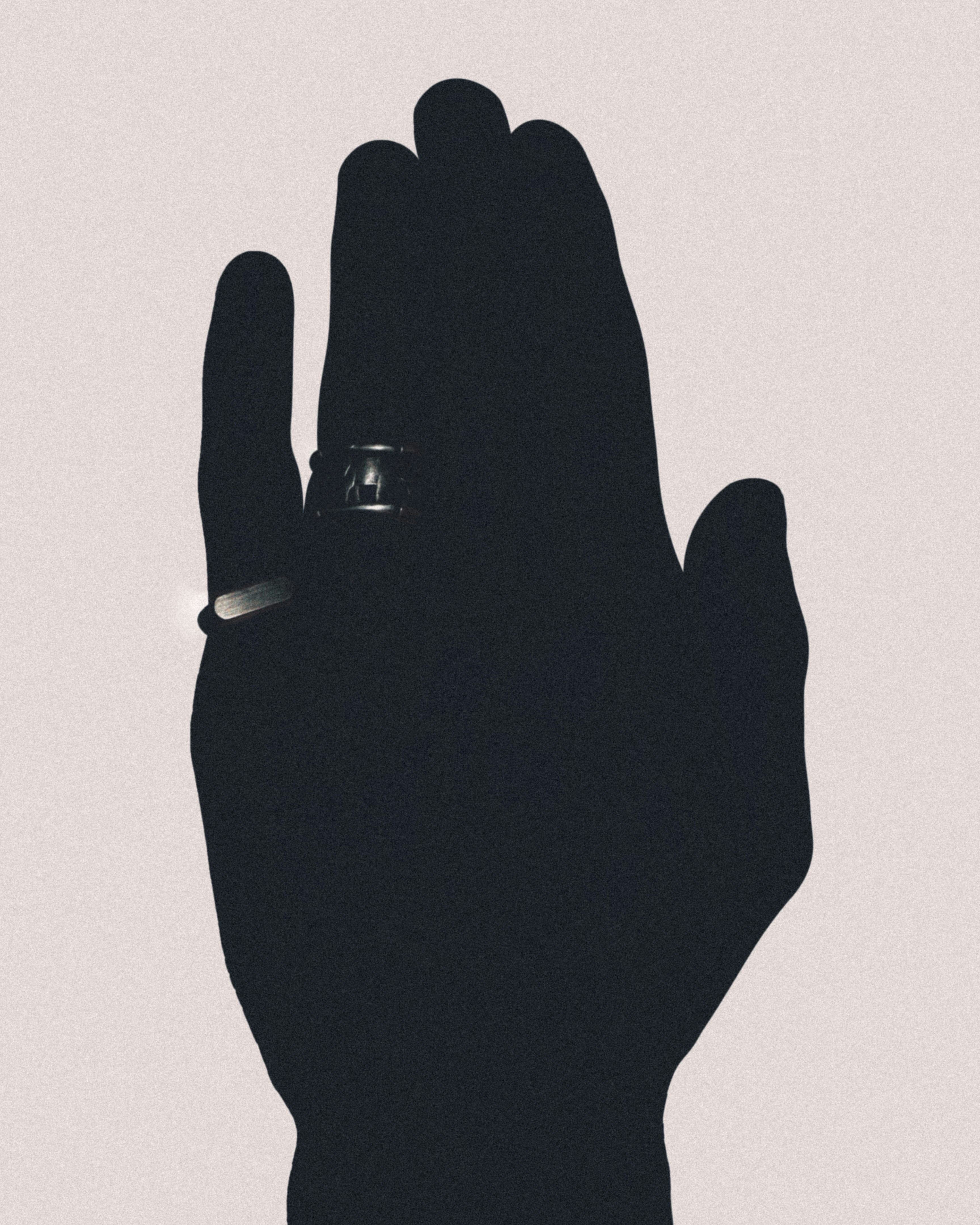Shadowed Gesture: A Minimal Hand silhouette against pale backdrop