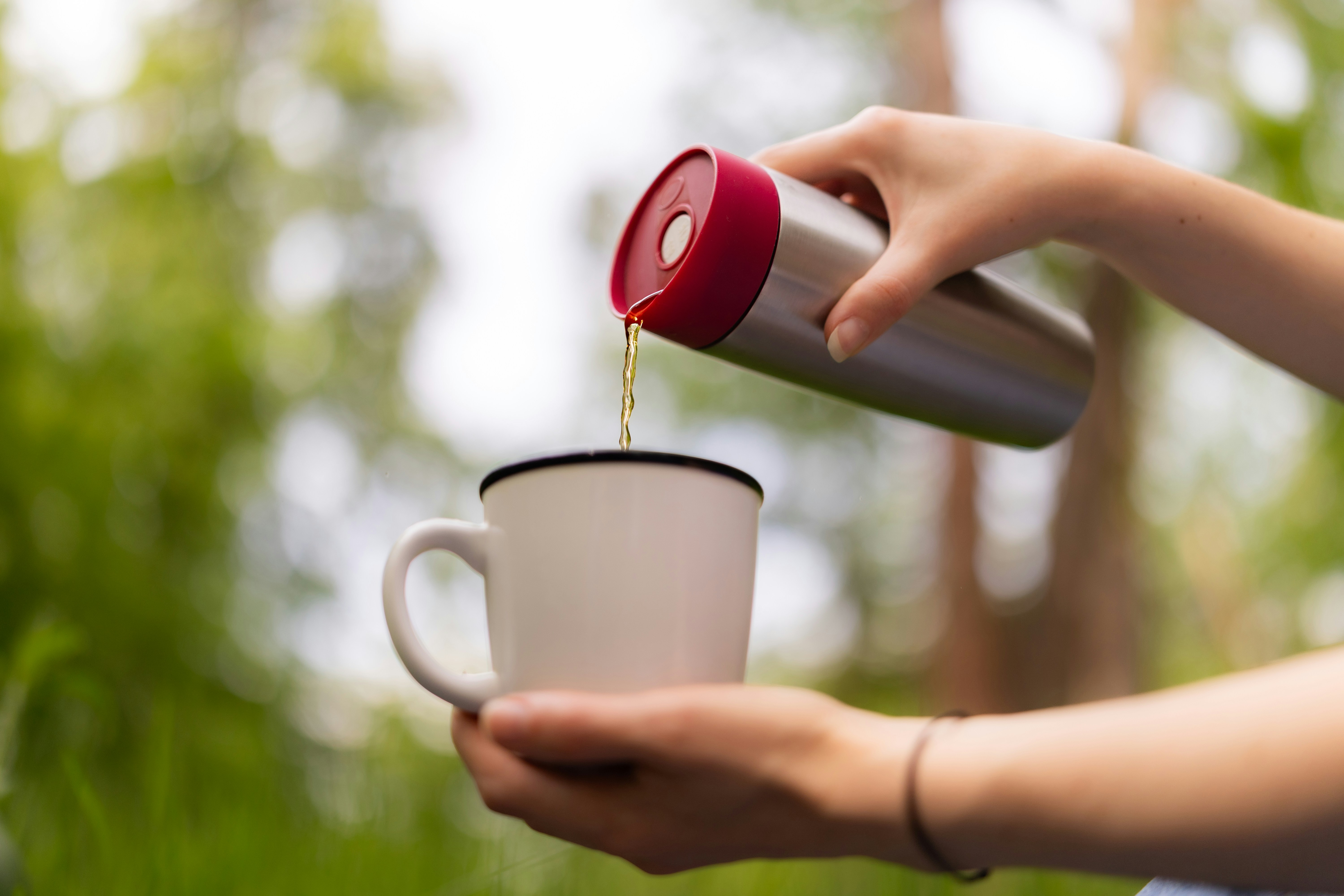 Pouring Light: A Delicate Stream into a White Mug