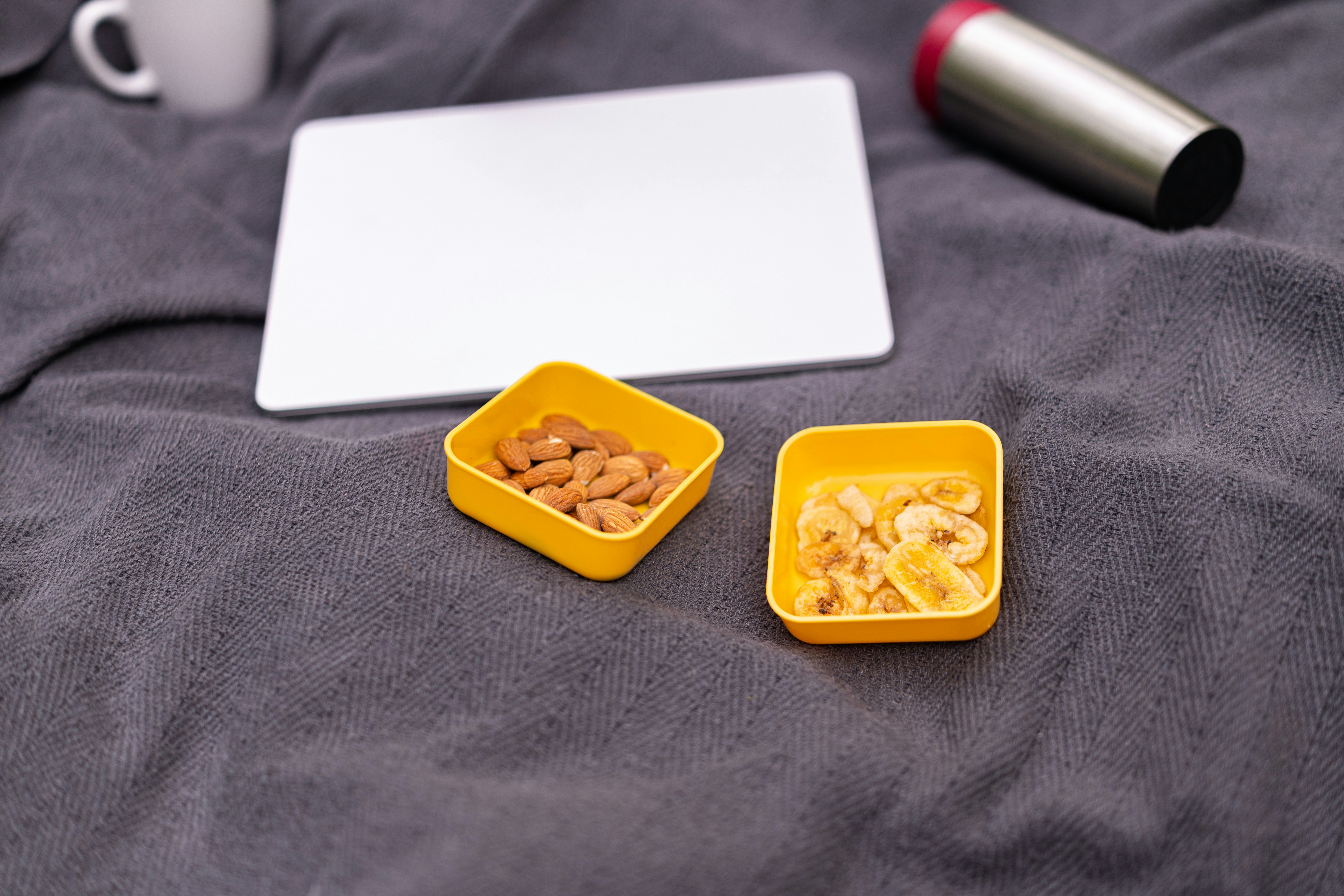 Yellow Snack Trays on a Dark Linen Surface