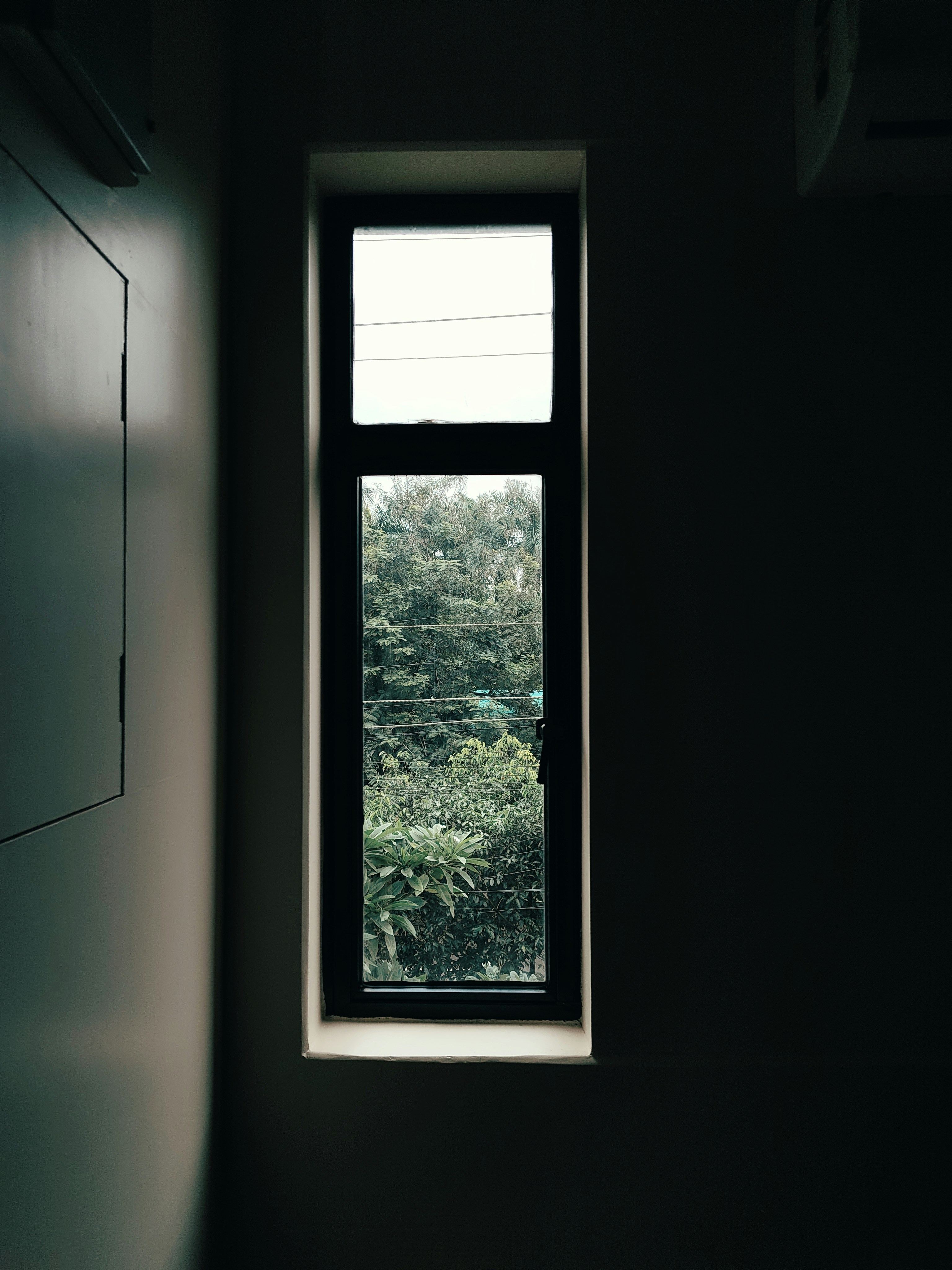 A Narrow Window to Outdoors: Quiet Light in a Dim Hall