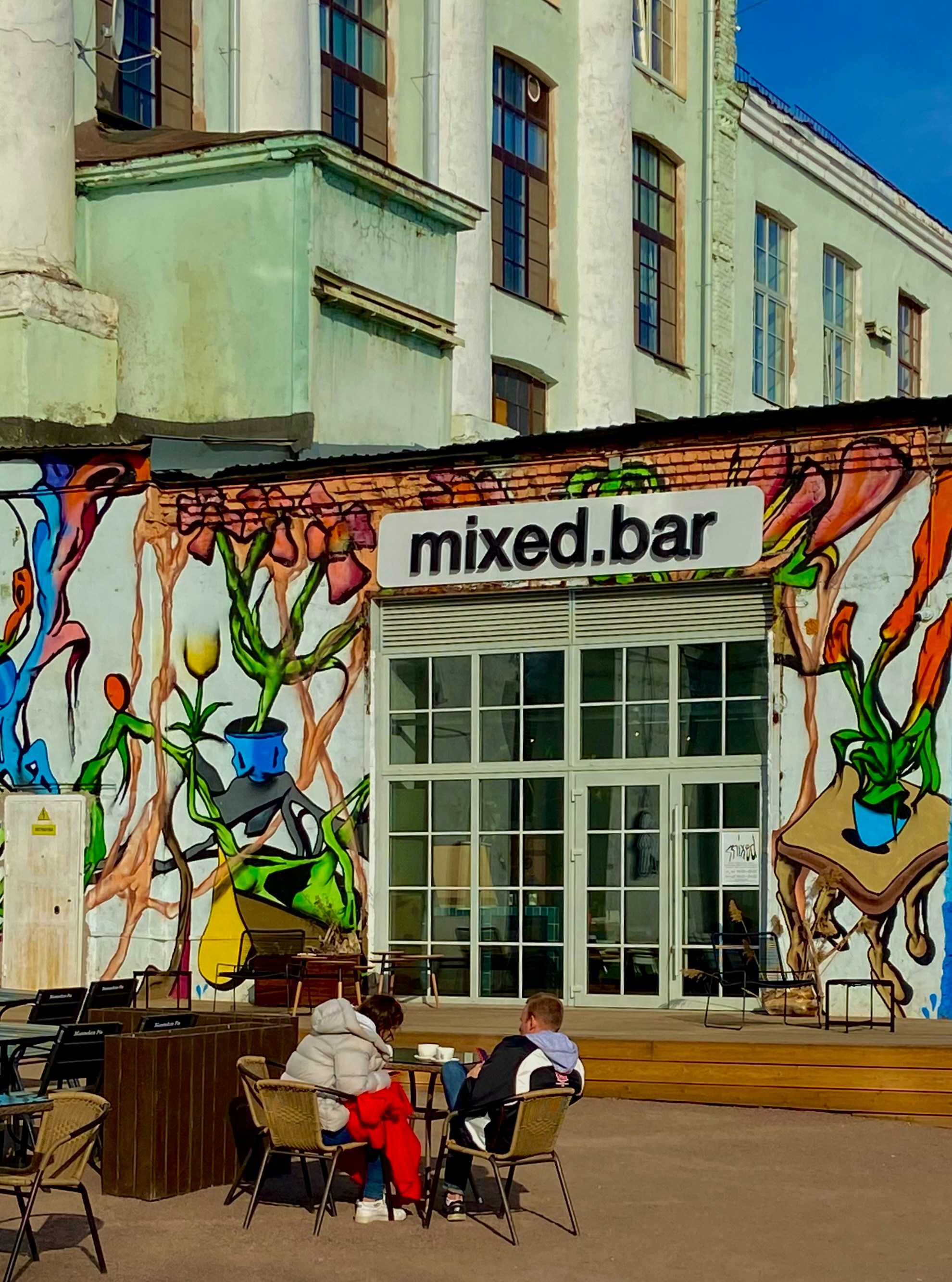  mural barfront shadows and colorful courtyard scene