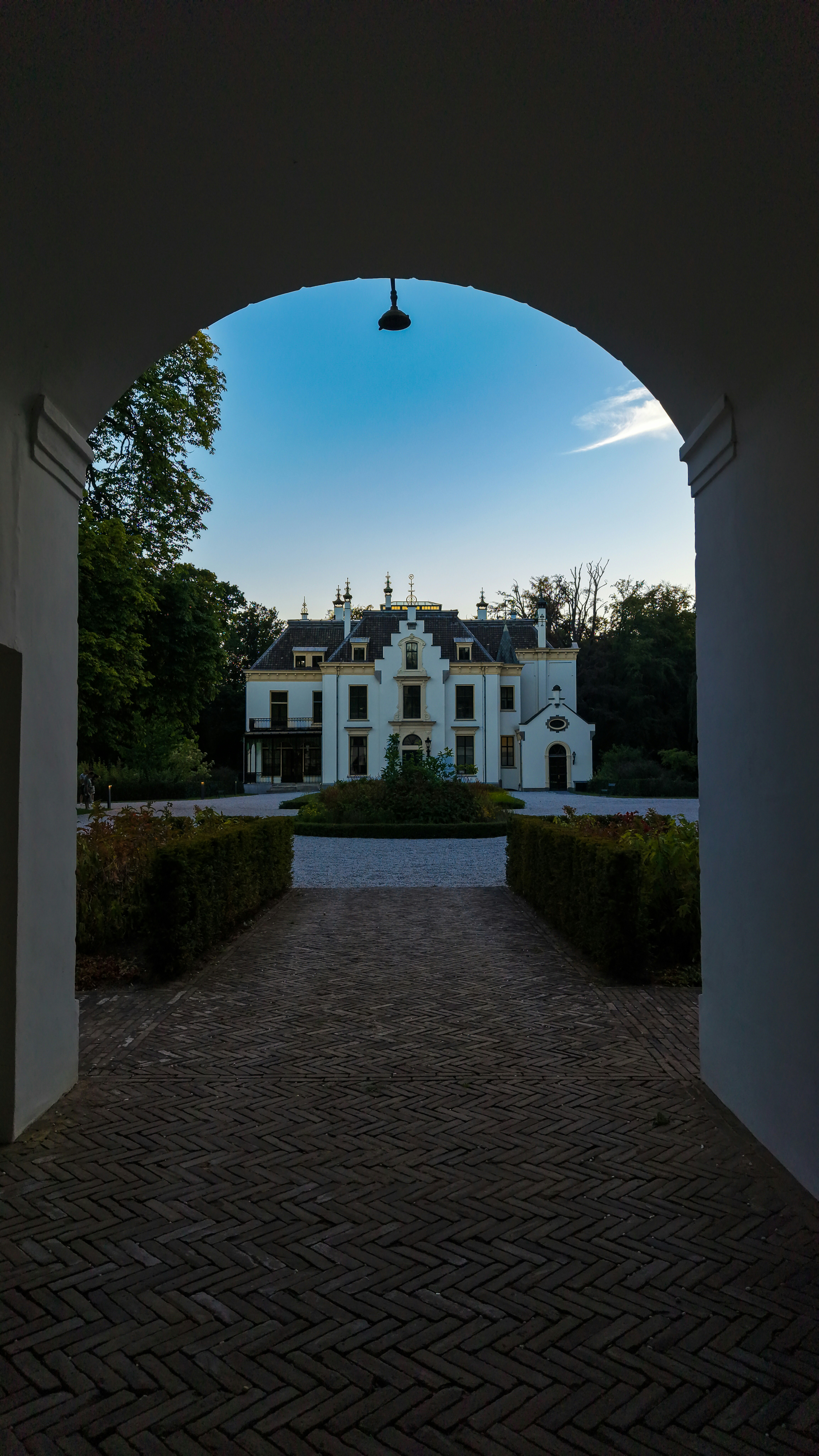 Archway to a Gilded Manor: Symmetry Framed by the Courtyard