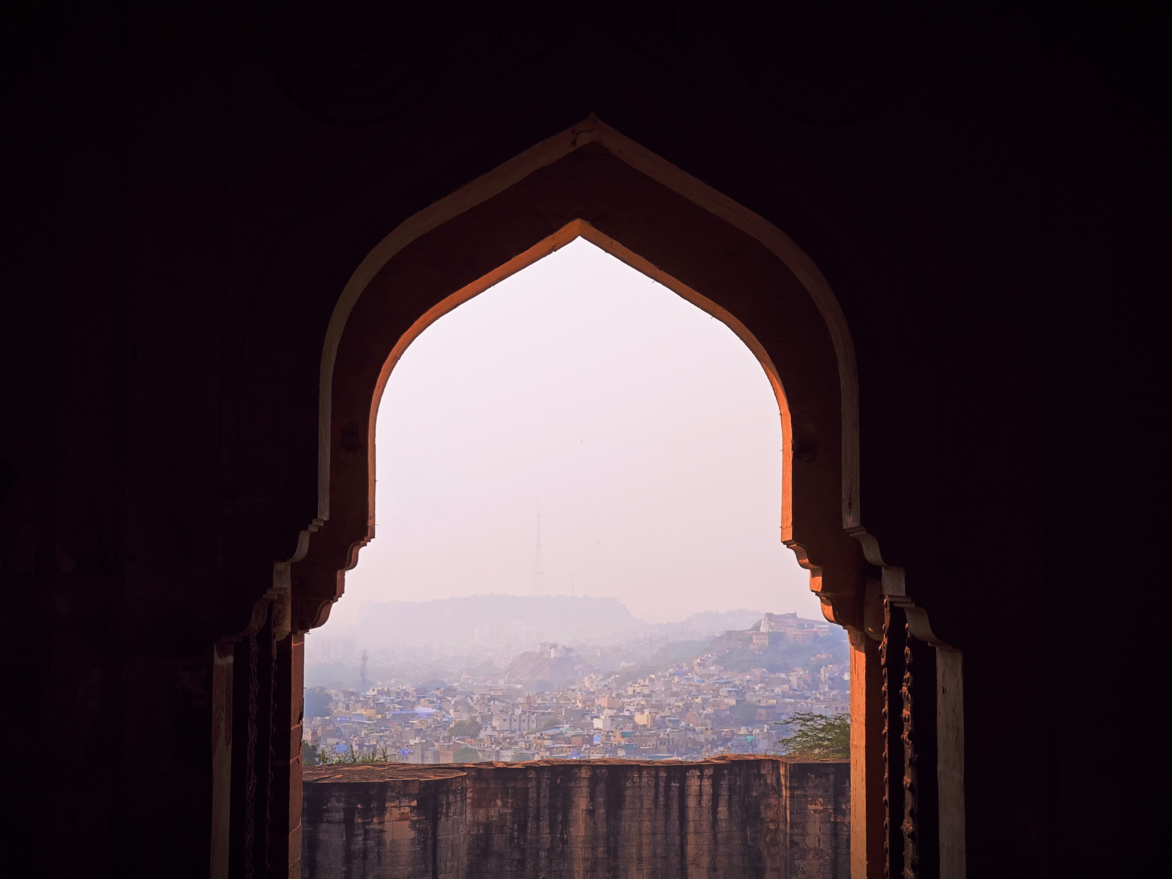 Archway View: Framed Skyline from a Deserted Corridor