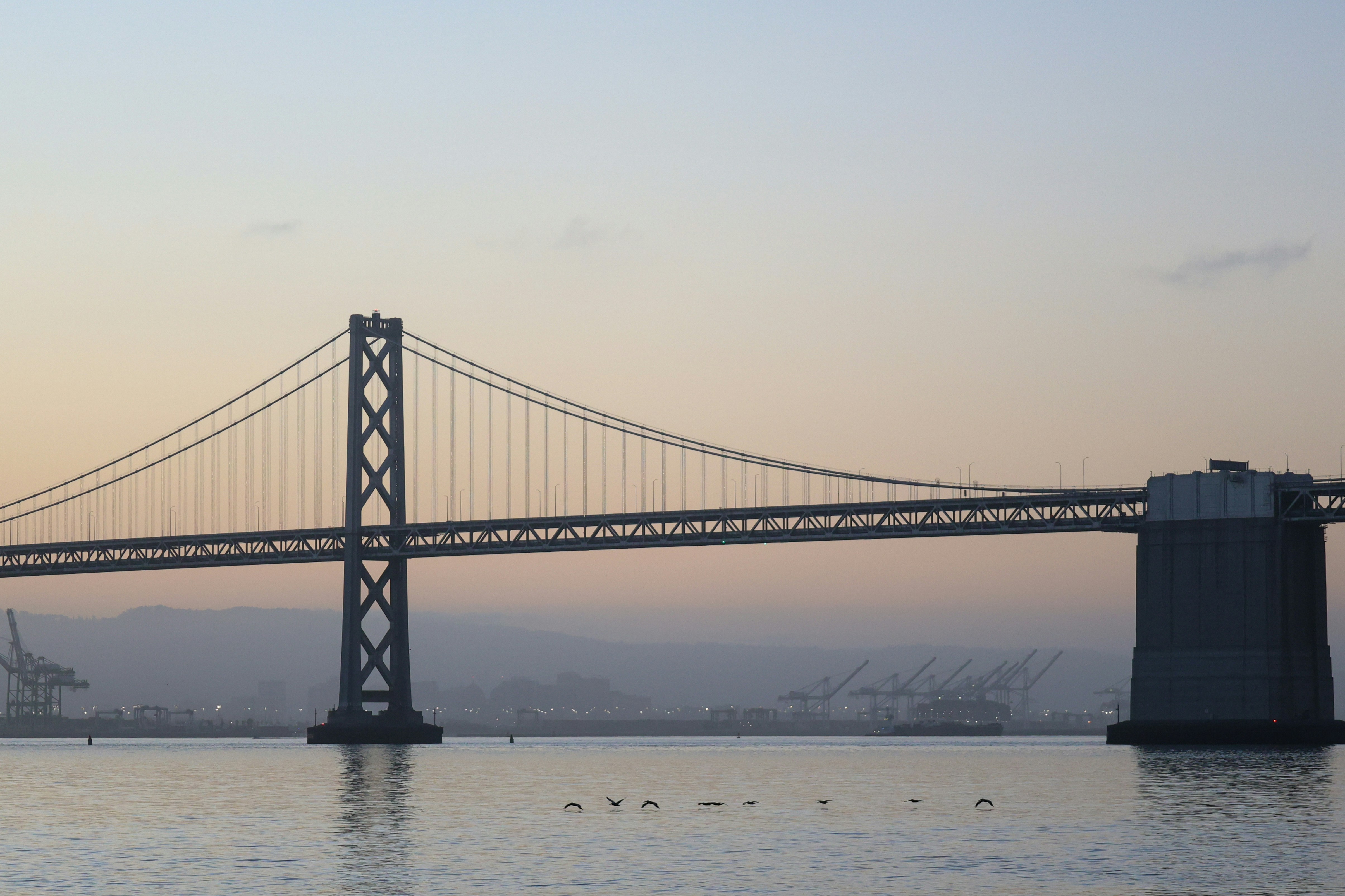 The Bay Bridge spanning the water at low sun in San Francisco