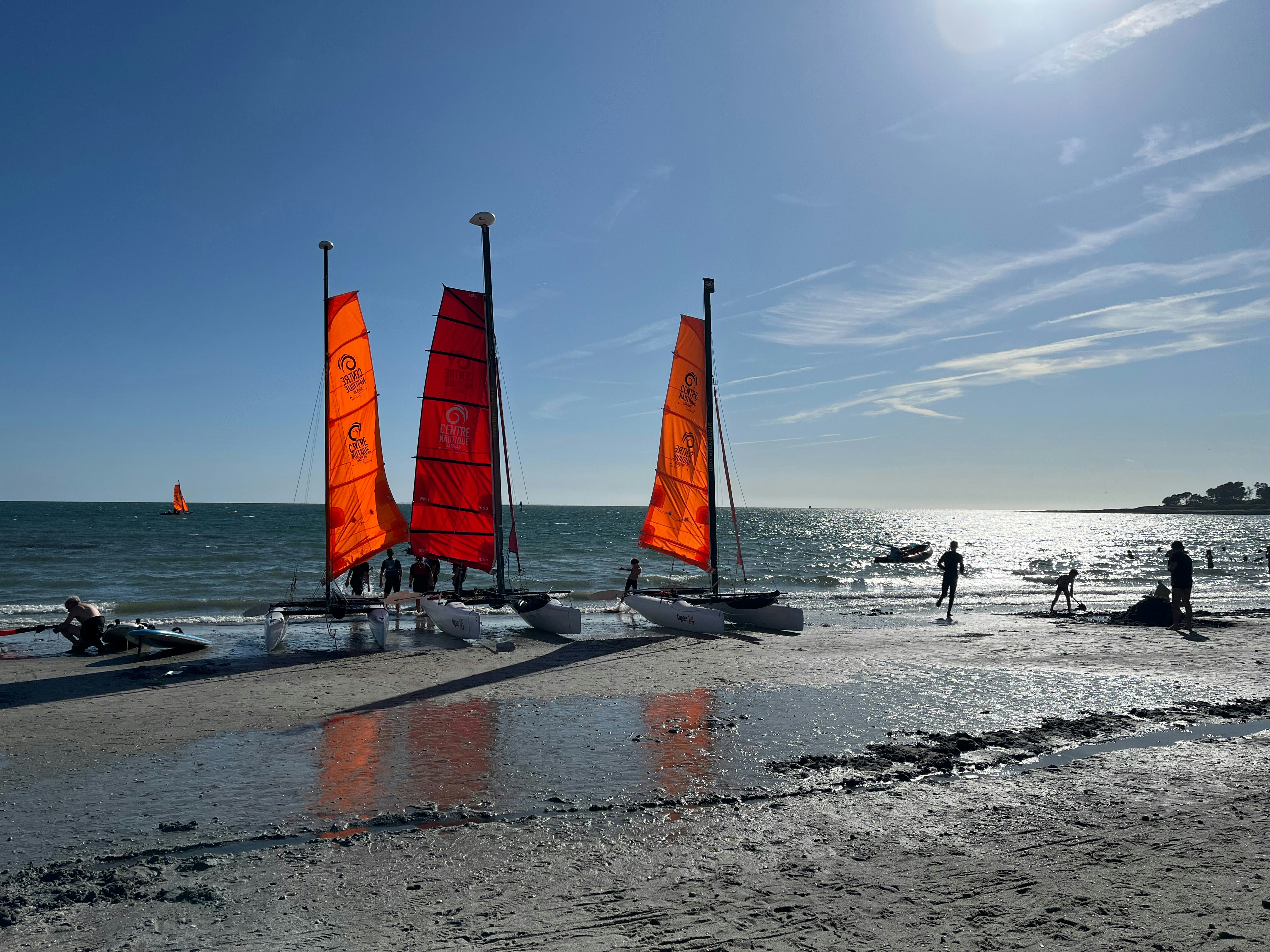 Orange Sails and Shoreline Calm at Distant Horizon
