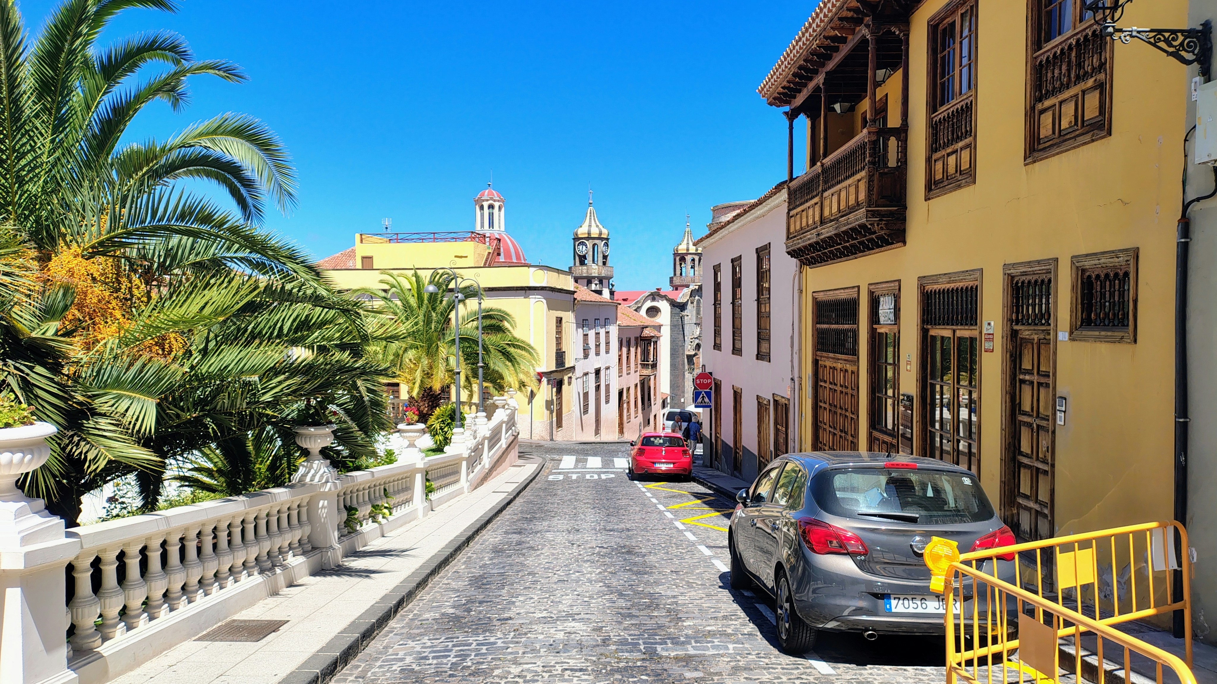 Sunlit Calle Slope: Colorful Townscape with Scenic Balcony Corridor