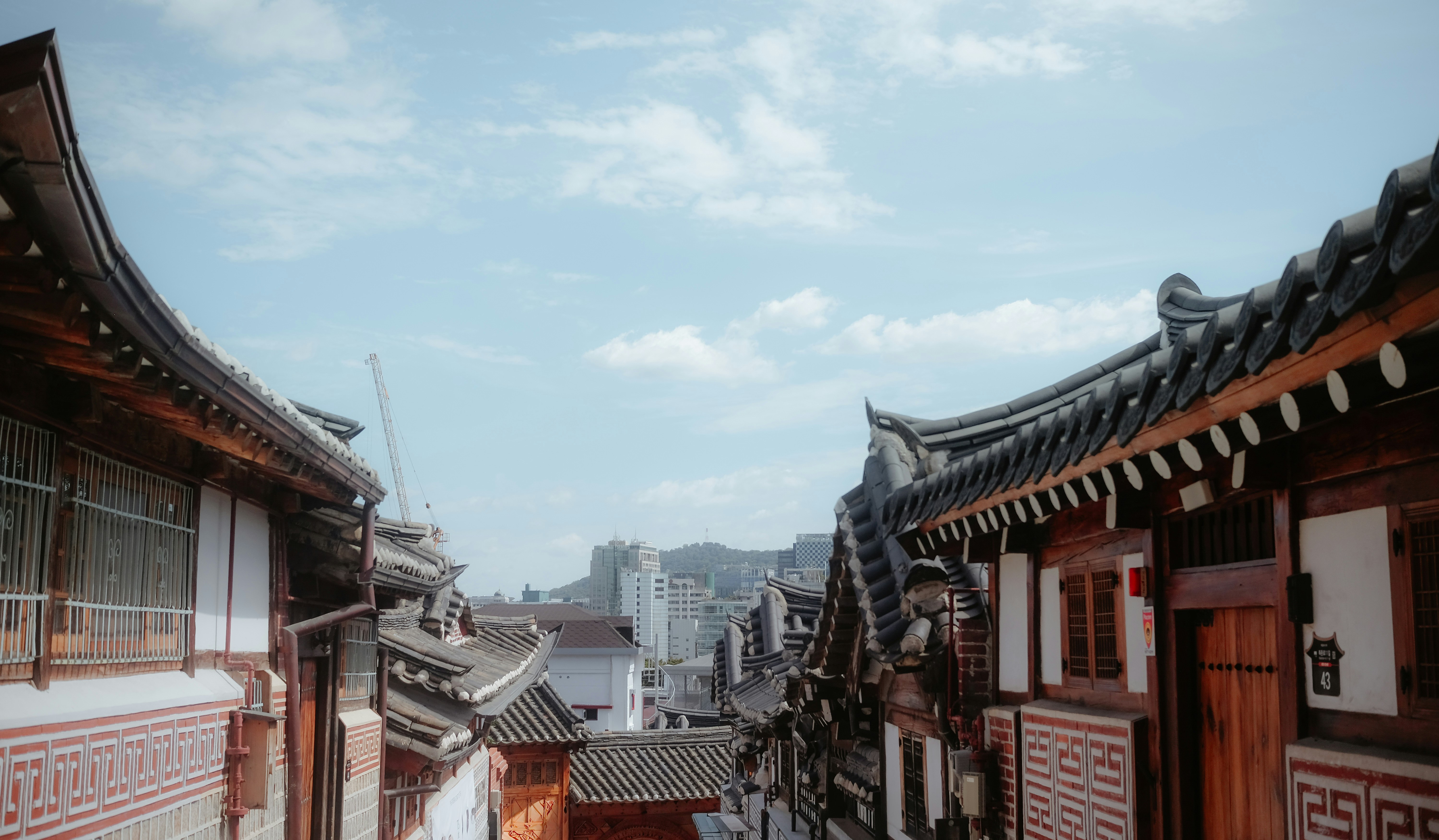 Rooftop Corridor: Traditional Rooflines Framing a Modern City