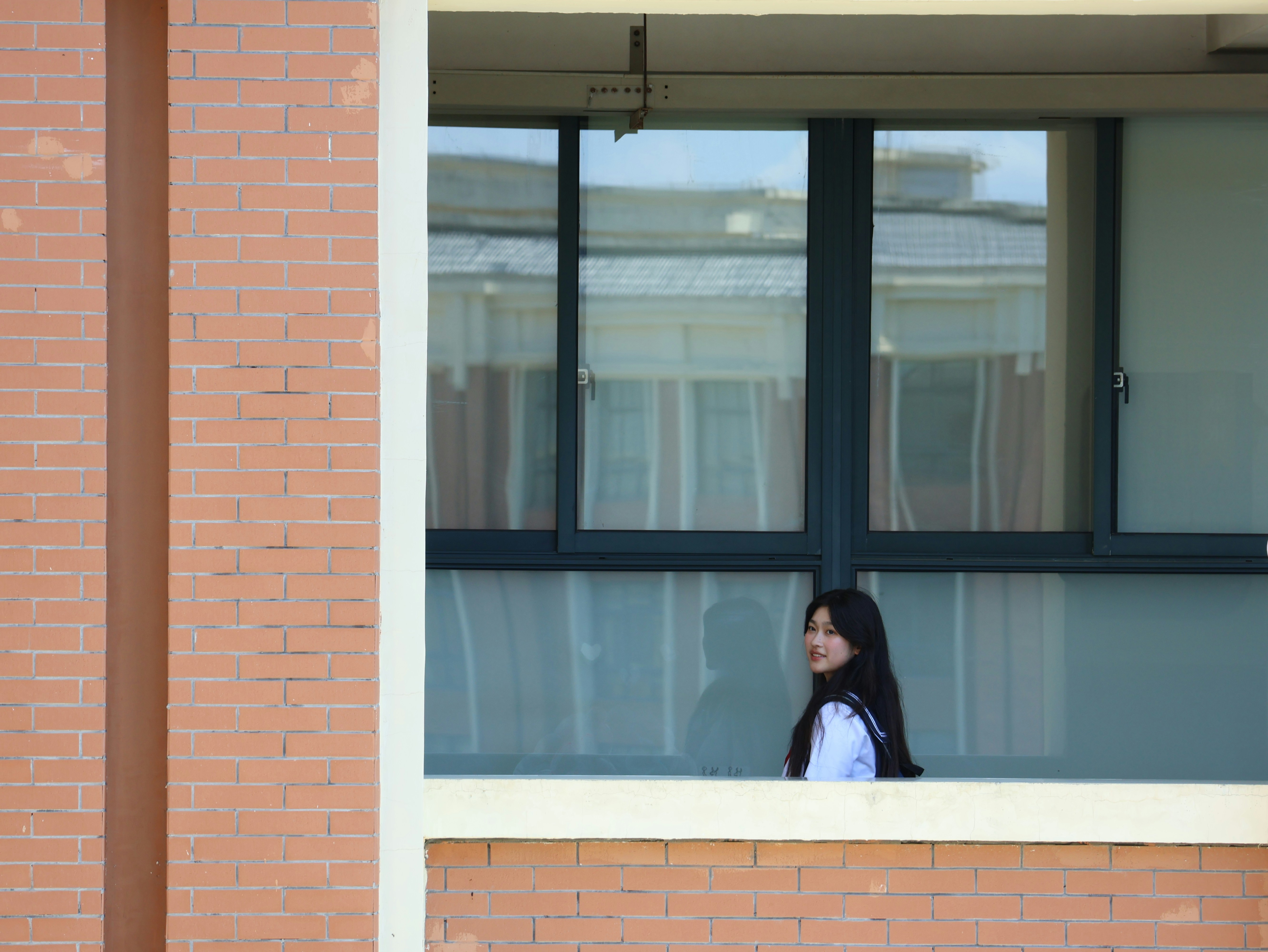 Windowed Gaze: A Portrait at the Campus Balcony