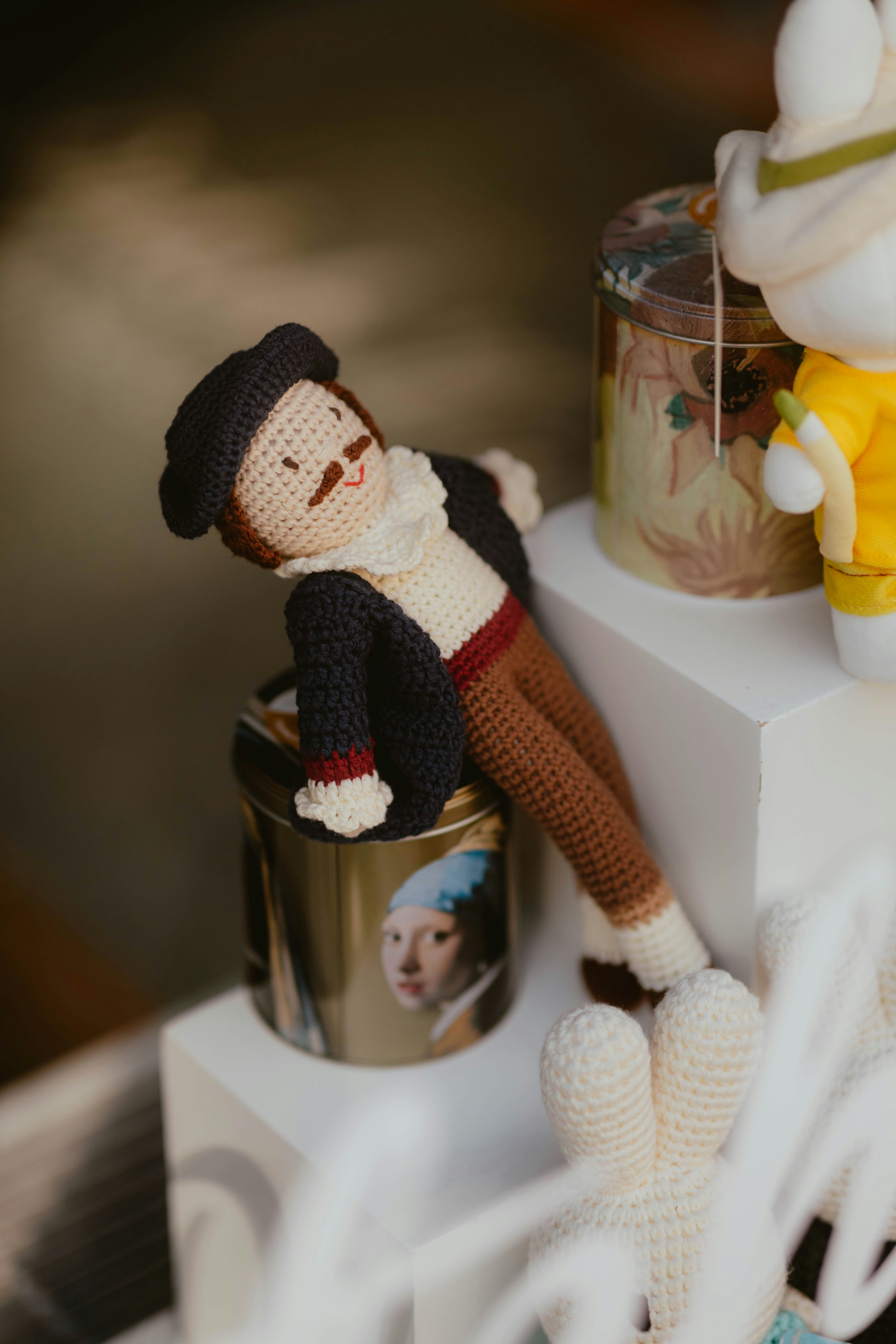 Knit-Valet: A Crocheted Nomad Perched Among Trinkets