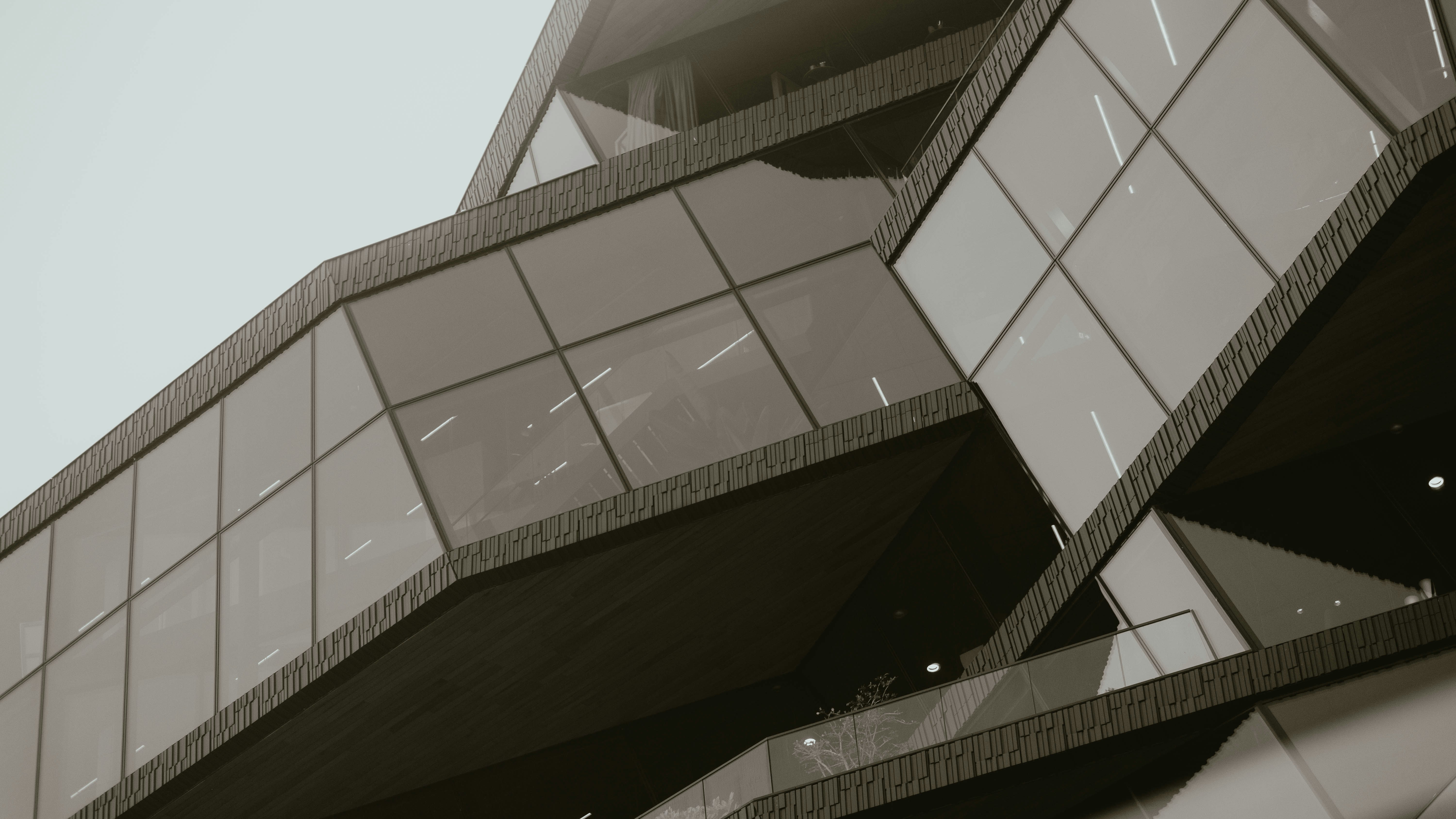 Intersecting Glass: A Geometric Facade in Monochrome Light