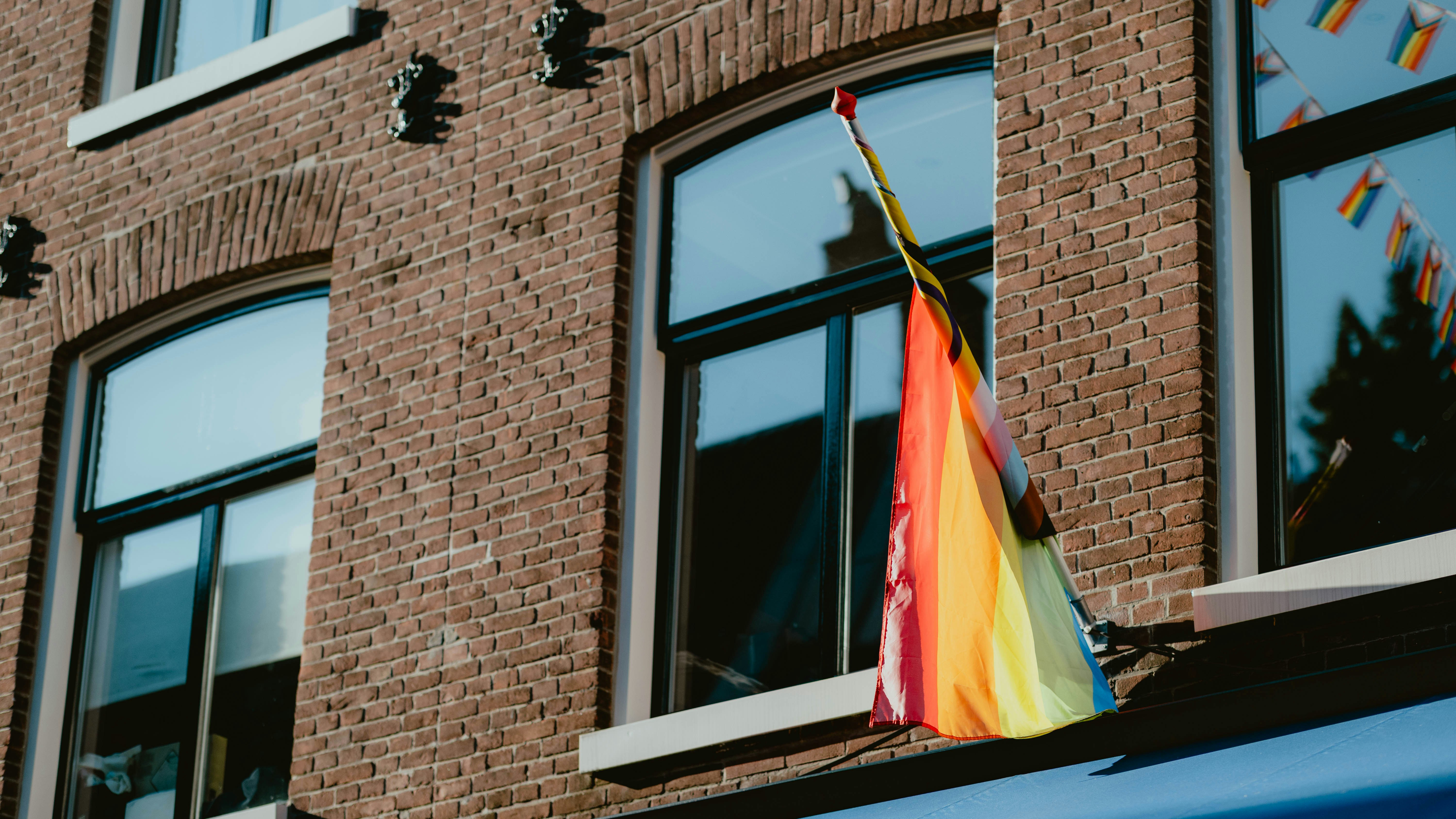 Flag against Brick: Pride on a City Facade