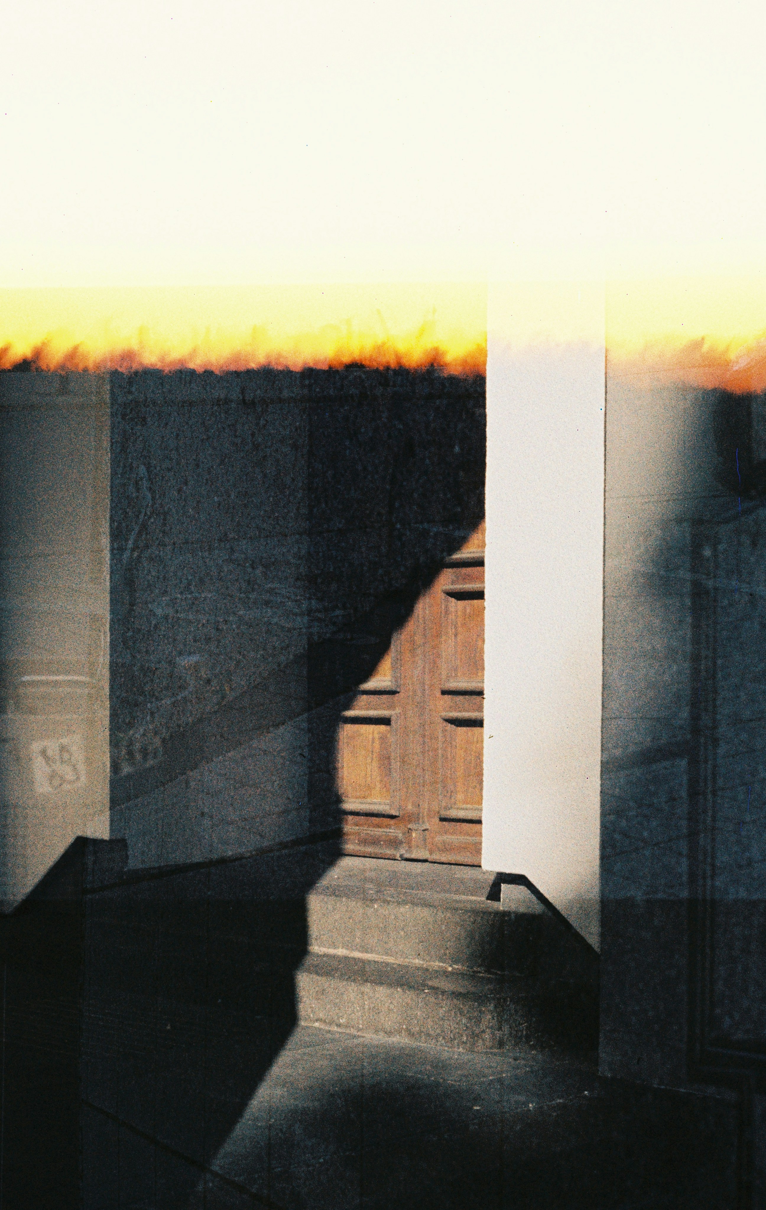 Shadowed Staircase with Framing Column and Warm Perimeter Light