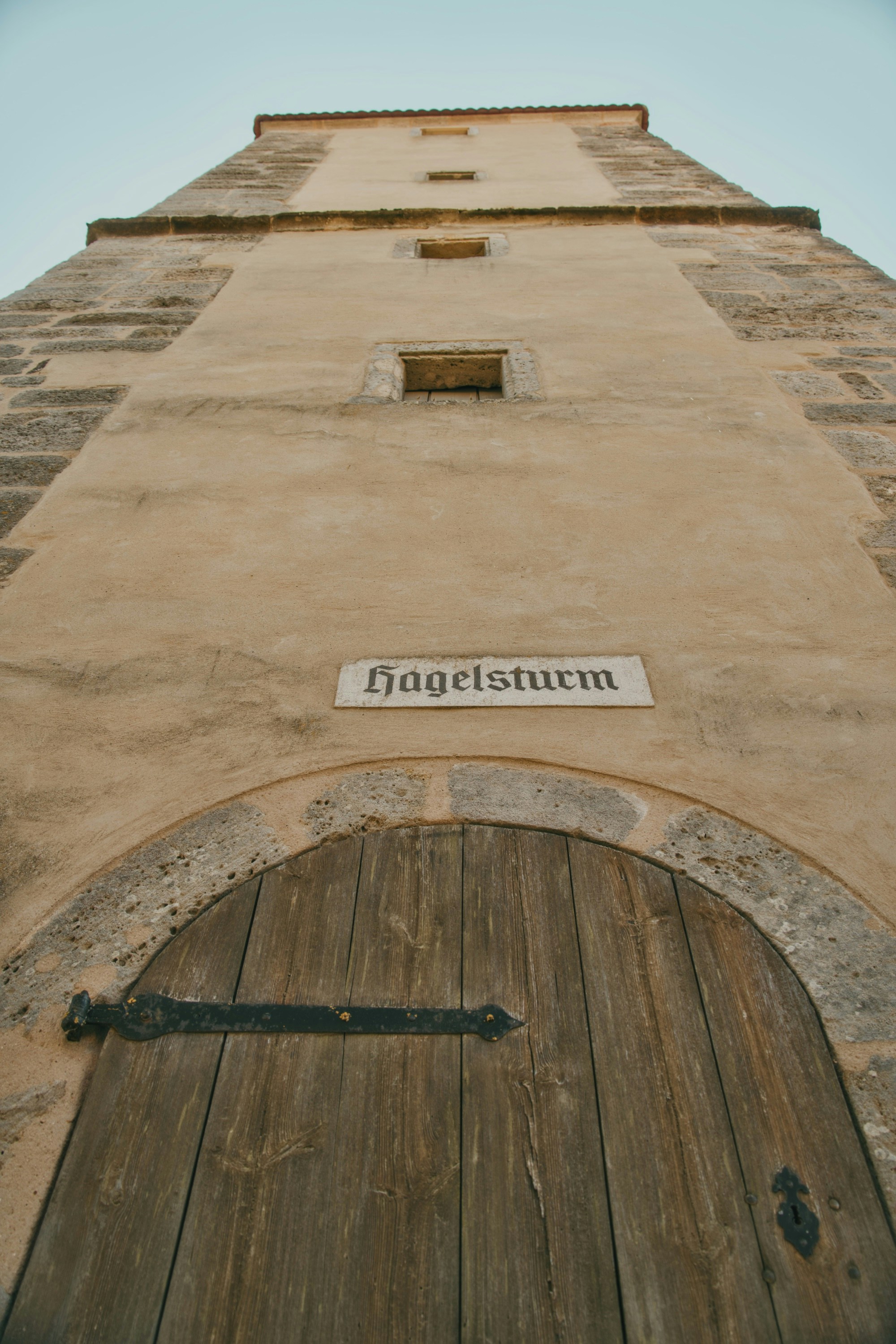 Towering Silence: An Aged Gatehouse Reaching Toward the Sky