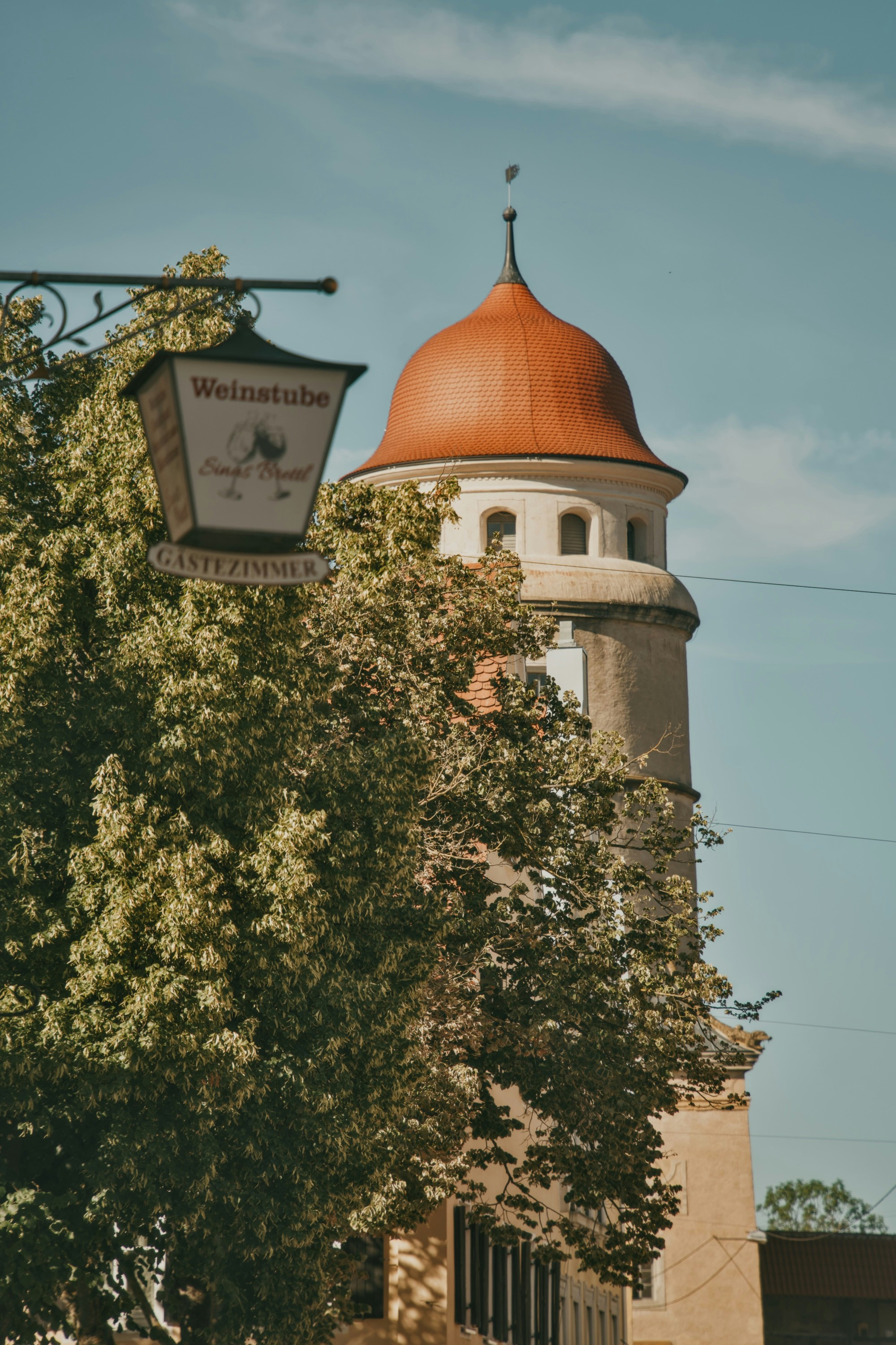 Towering Rooftop Anthem: A Tuscan-like Dome Amid LeafyFrames