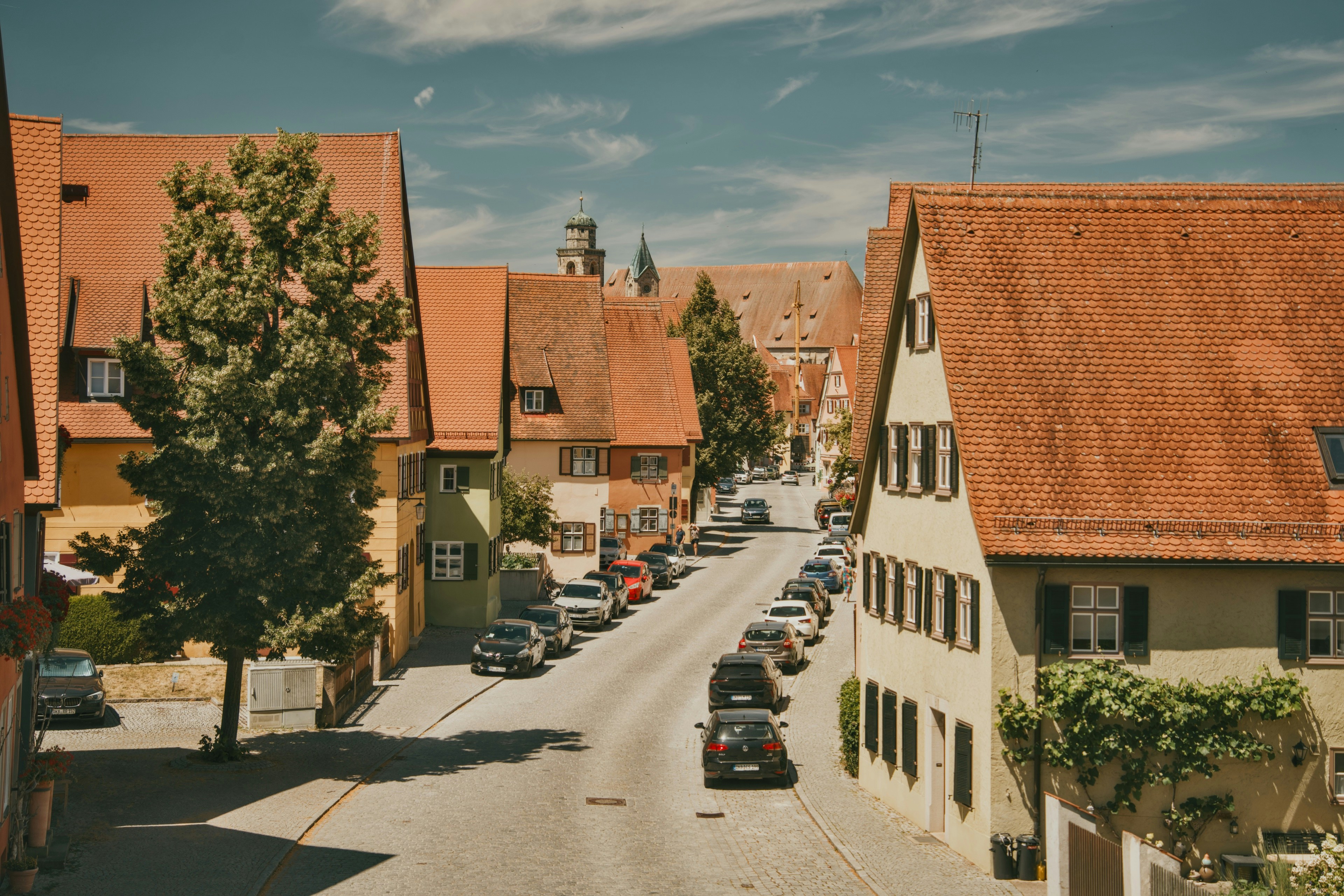 A Sunlit Bavarian Street: Cars Cue a Gentle Slow Down