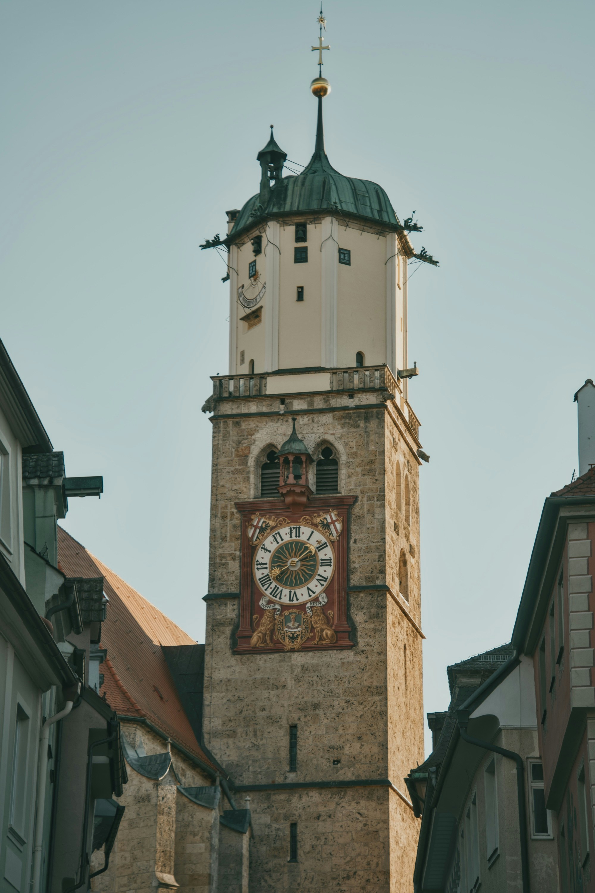 Clock Tower Rising Above Narrow Alpine Streets