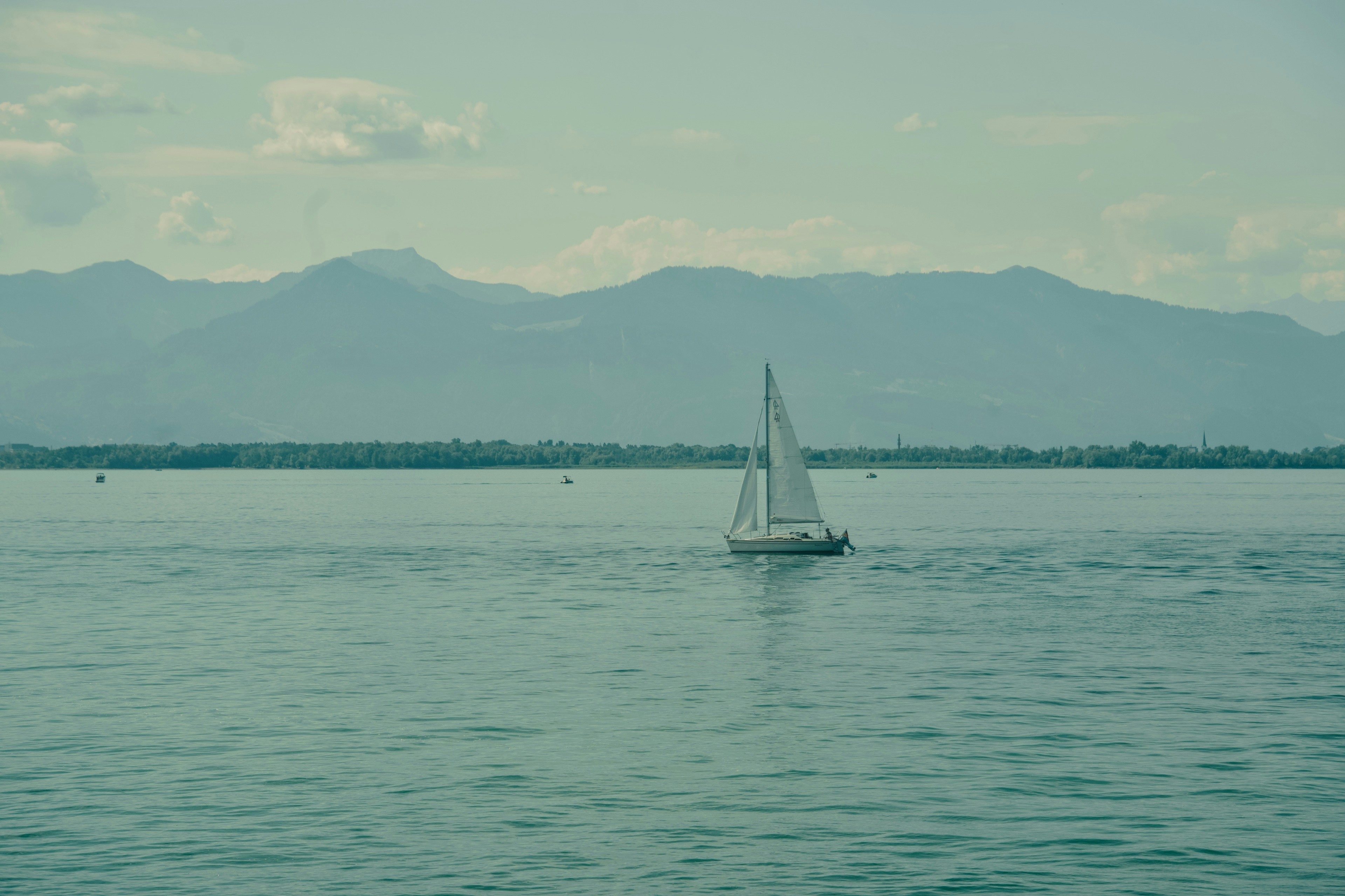 Solitary Sail on a Quiet Lake Under Quiet Mountains