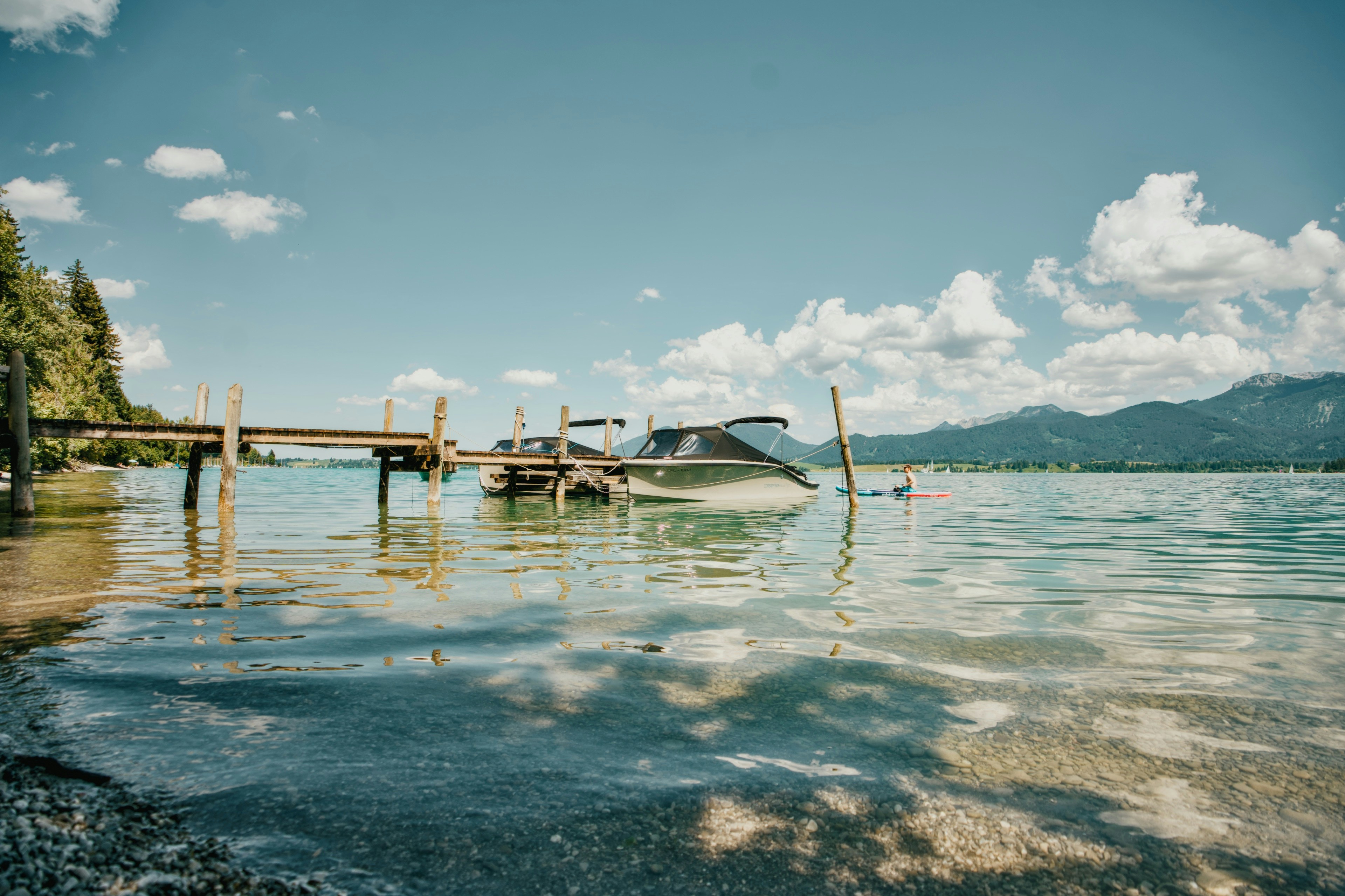 Boat at the Quiet Pier on a Lake Under a Clear Sky