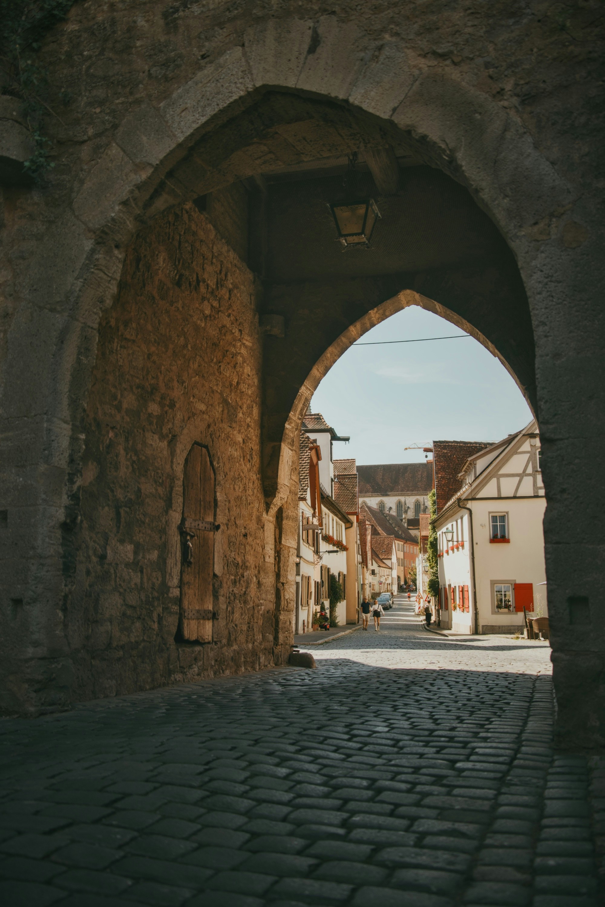 Through the Stone Arch to a Sunlit Street