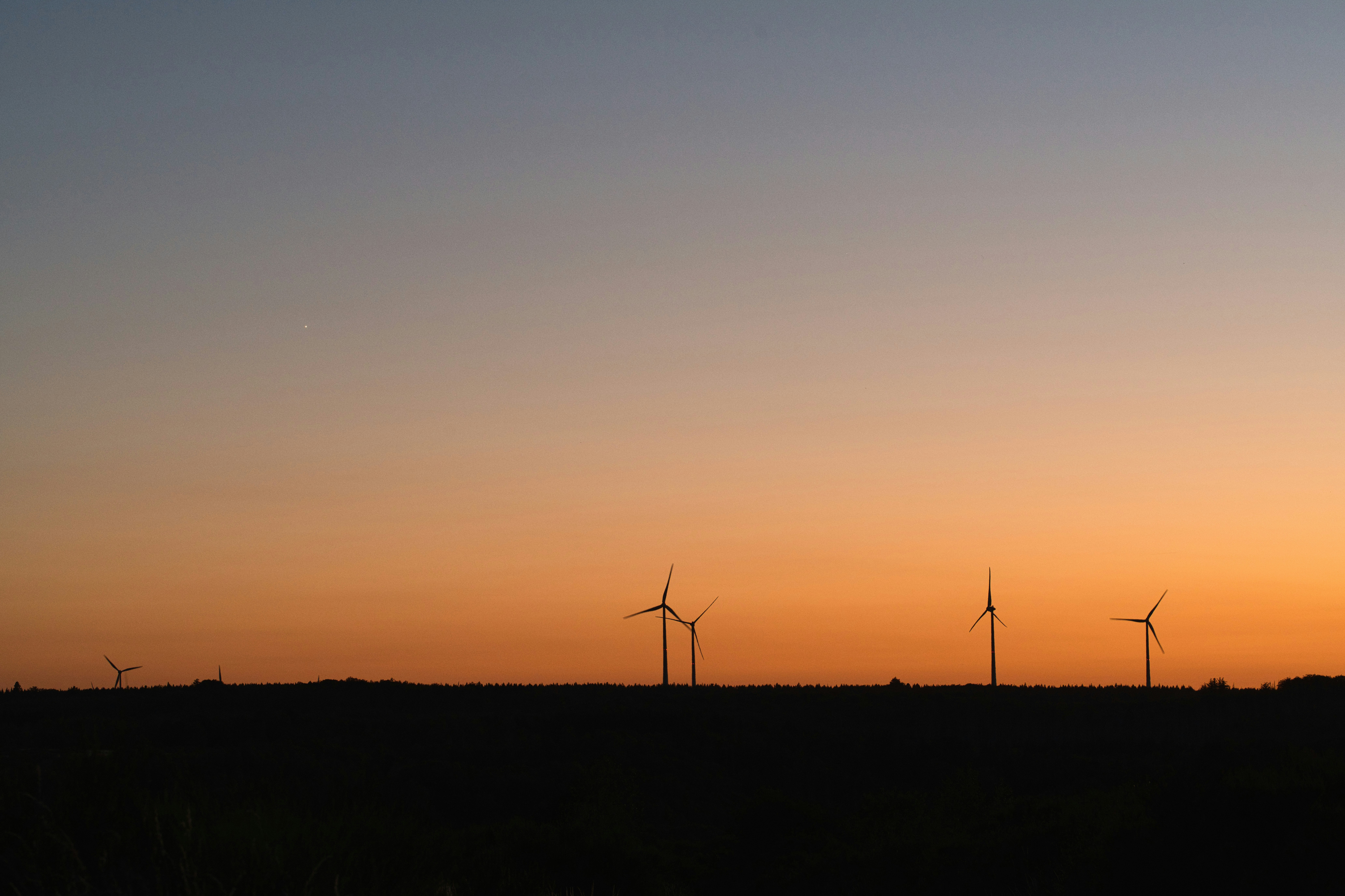 Windmills at Dusk: Silent Sentinels on the Horizon