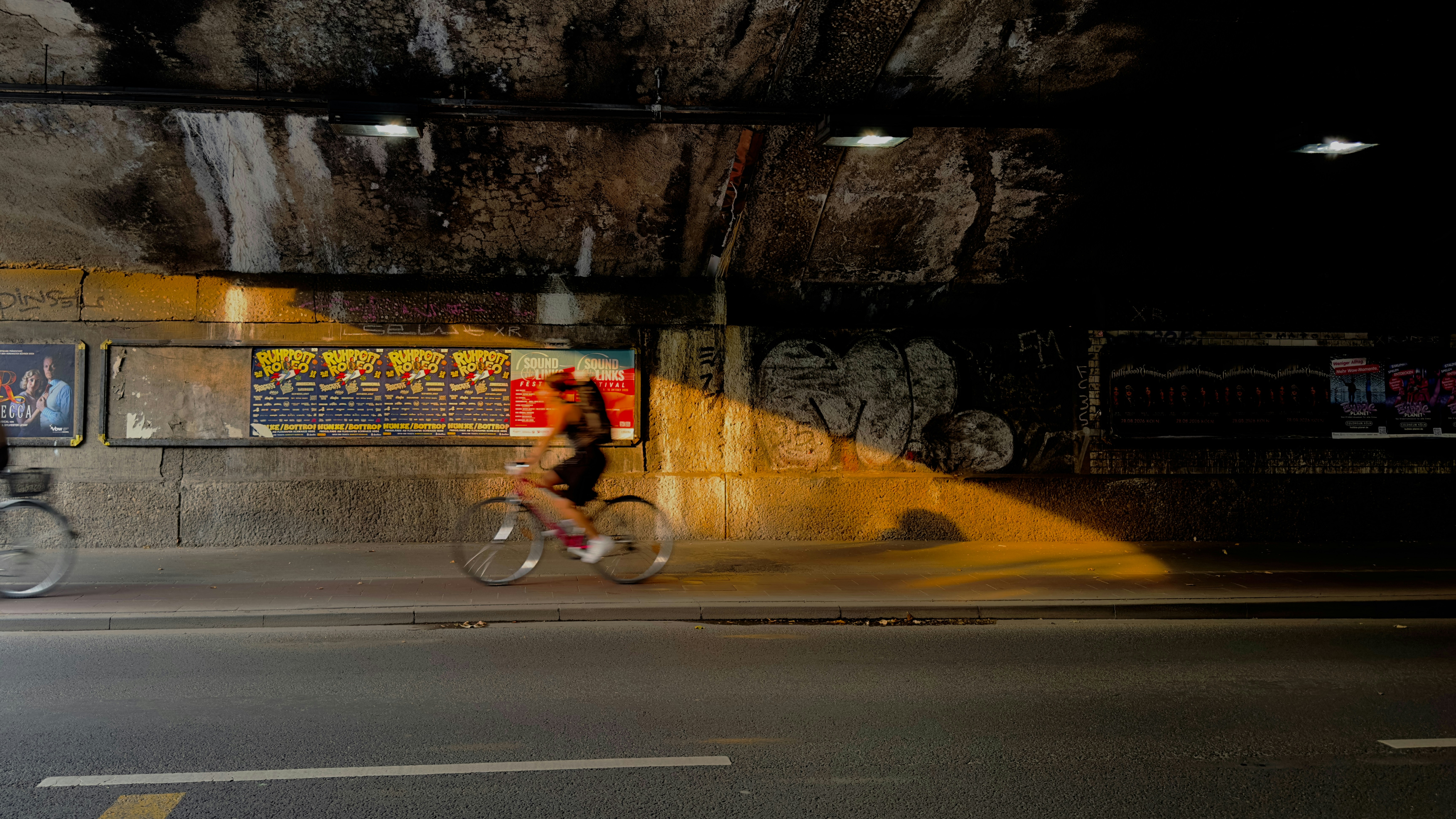 Motion Under the Highway Dome: Cyclist in a Neon Corridor