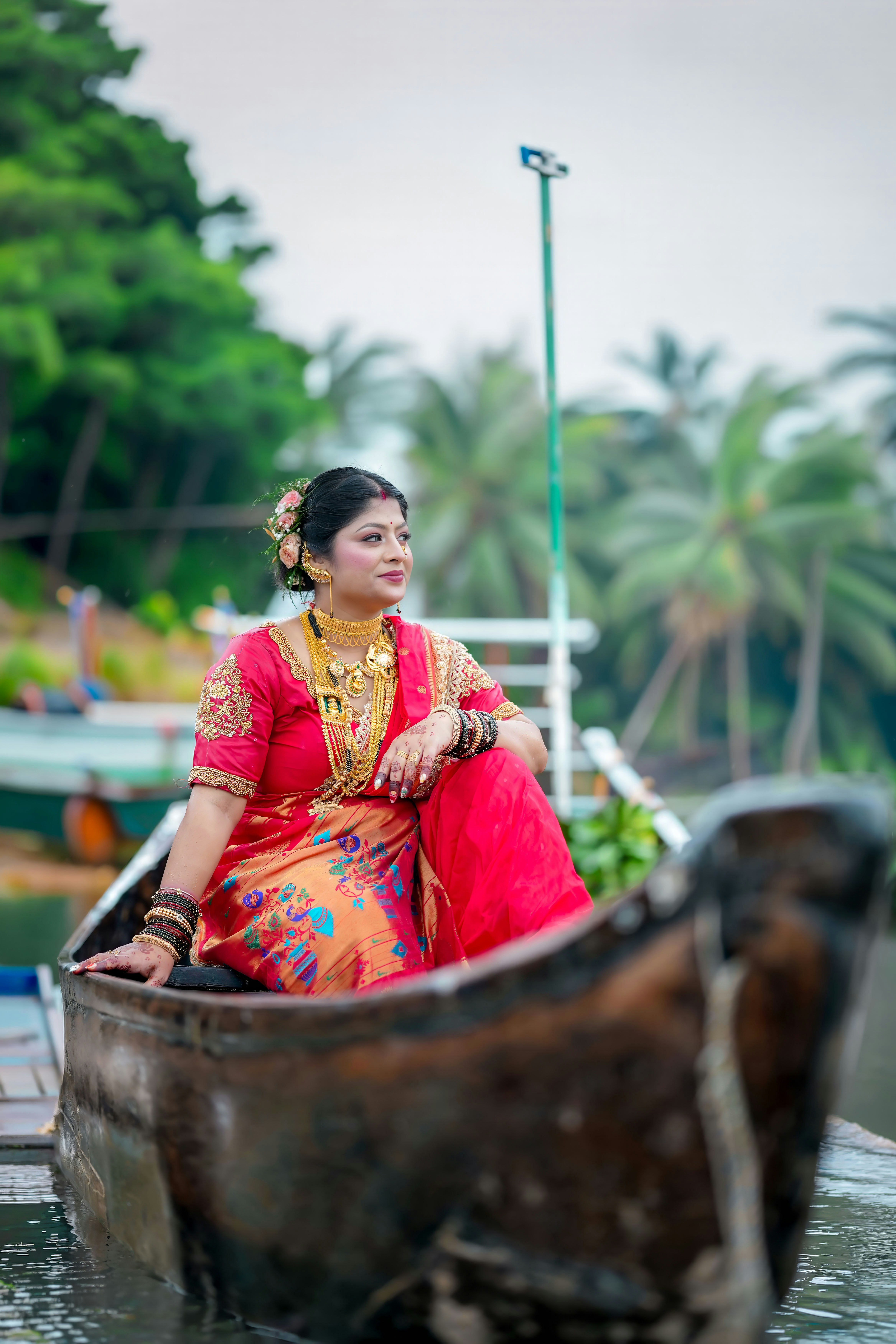 Bride in Scarlet and Gold Adrift in a Serene Boat